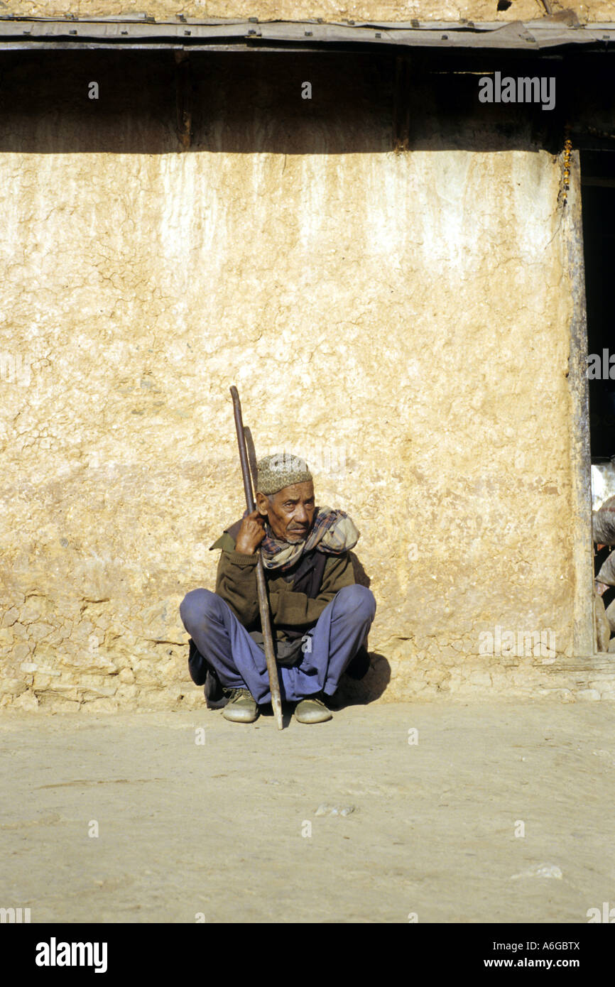 older man of the Newar people, crouching in front of cladding, Nepal ...