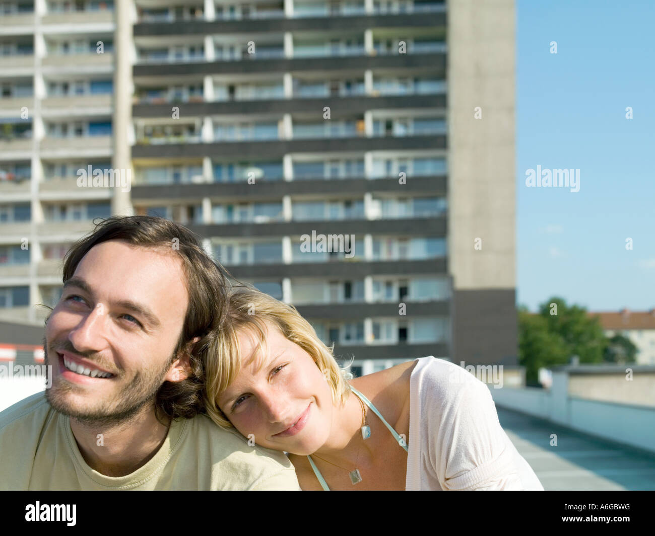 Young couple by apartment building Stock Photo - Alamy