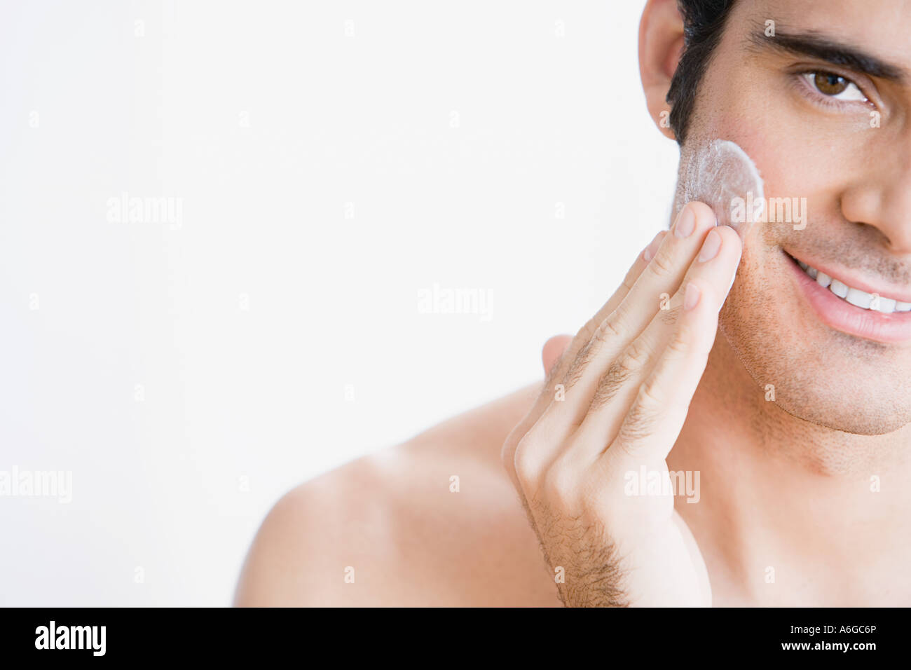 Man applying moisturiser Stock Photo - Alamy
