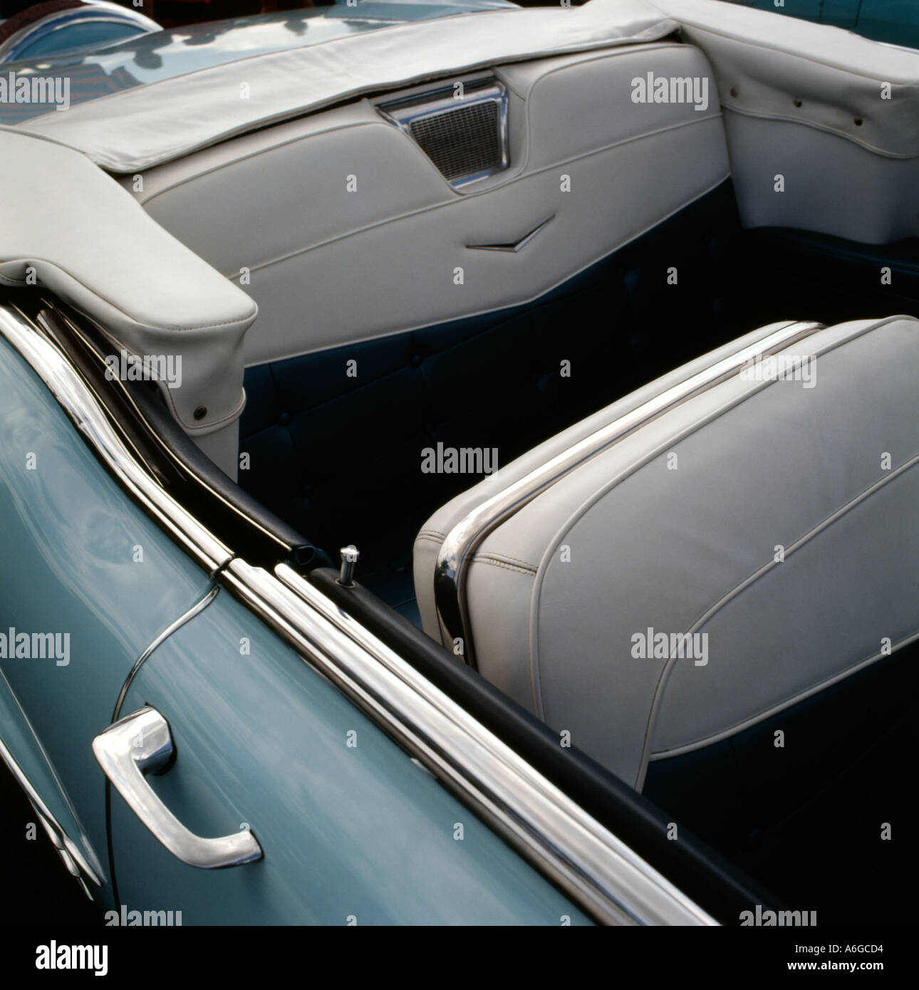 View looking into the back seats of a blue 1950s Cadillac convertible ...