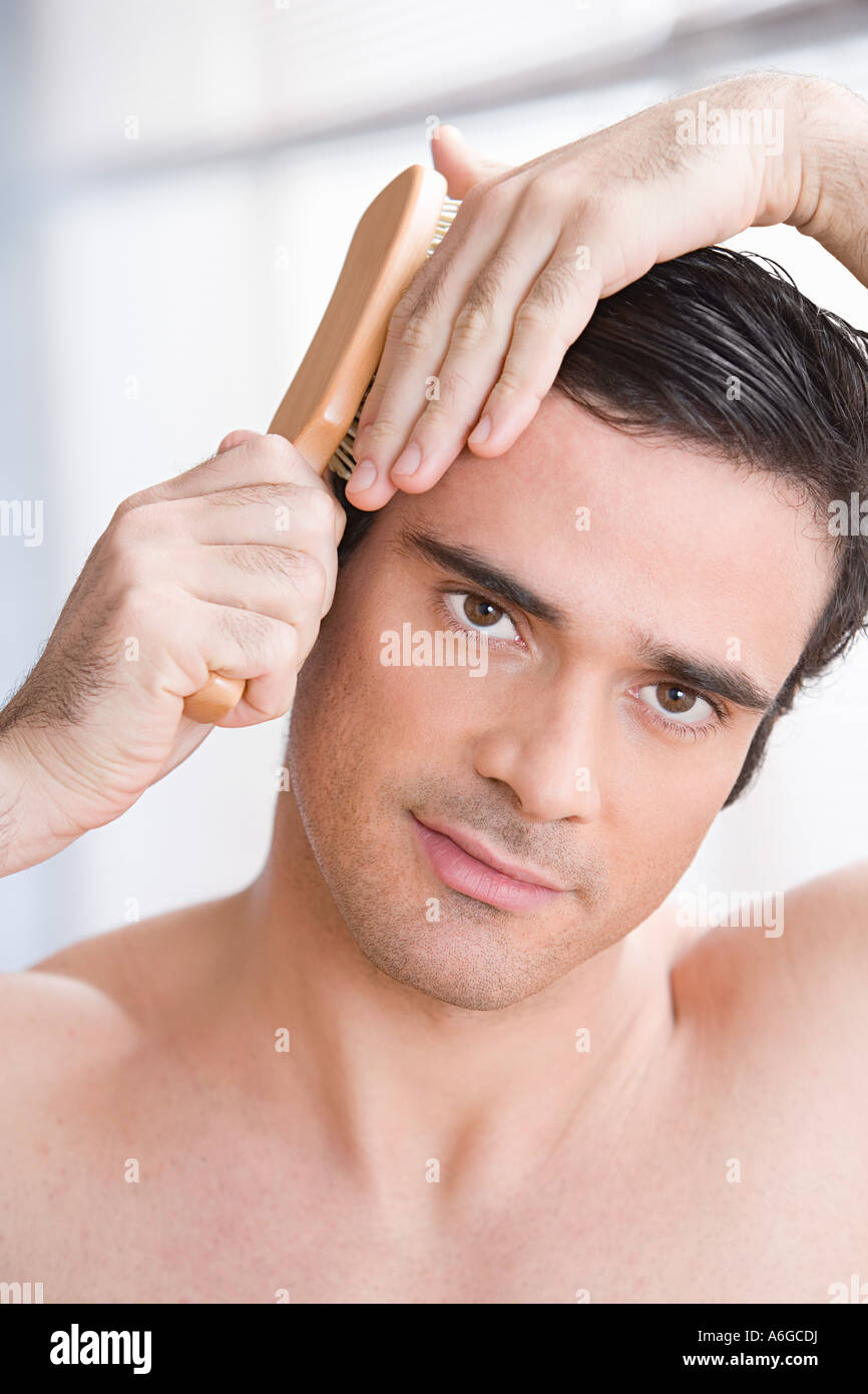 Man combing his hair Stock Photo - Alamy