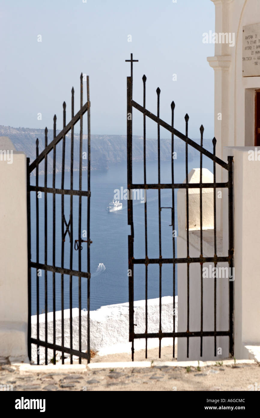 Wrought iron gates with ships caldera rim and Aegean sea beyond ...