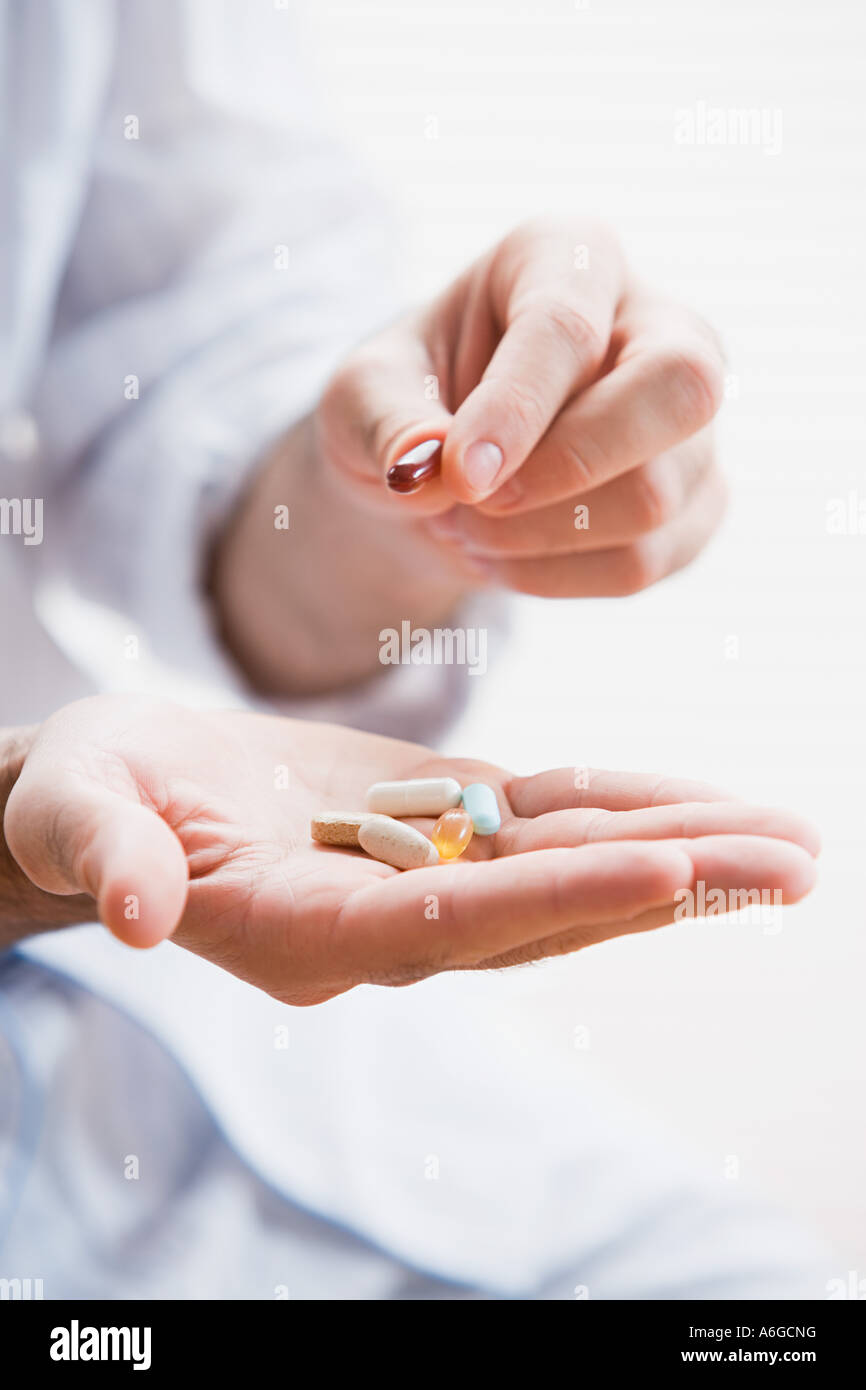 Man holding tablets Stock Photo - Alamy