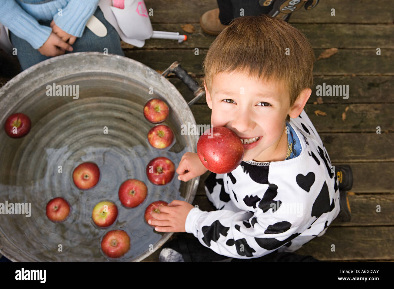 Boy apple bobbing Stock Photo - Alamy