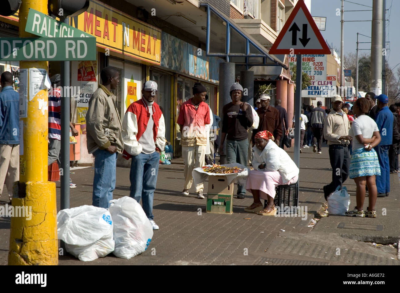 South Africa Johanesburg Yeoville district passers by on the pavement ...