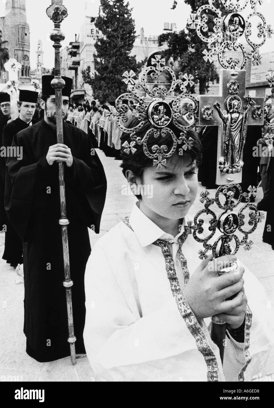 young Palestinian greek orthodox christian holding cross at the front ...