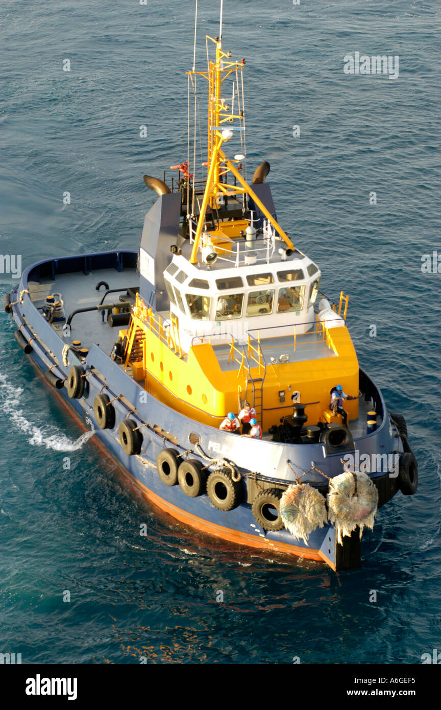Tug boat pushing to help docking of the Princess Danae in the port of ...