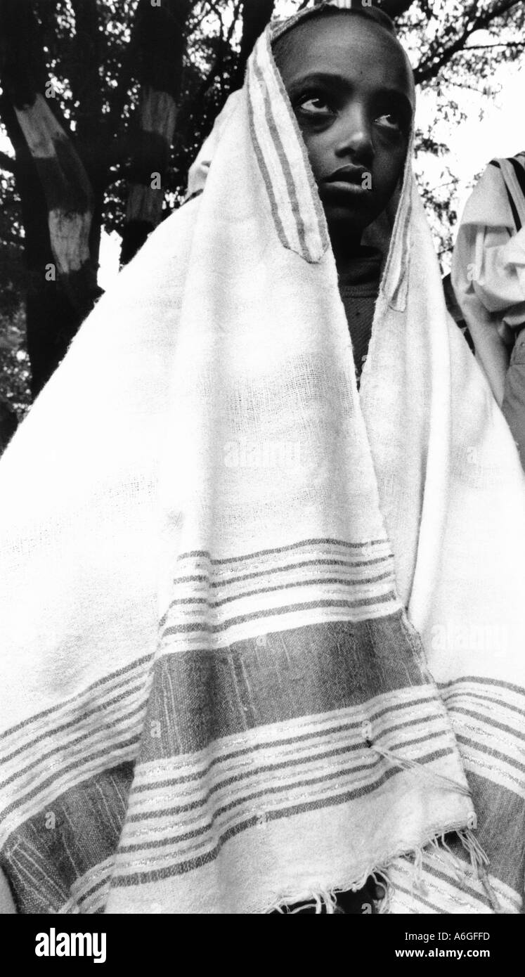 boy wearing a Talith prayer shawl covering his head with it Stock Photo ...