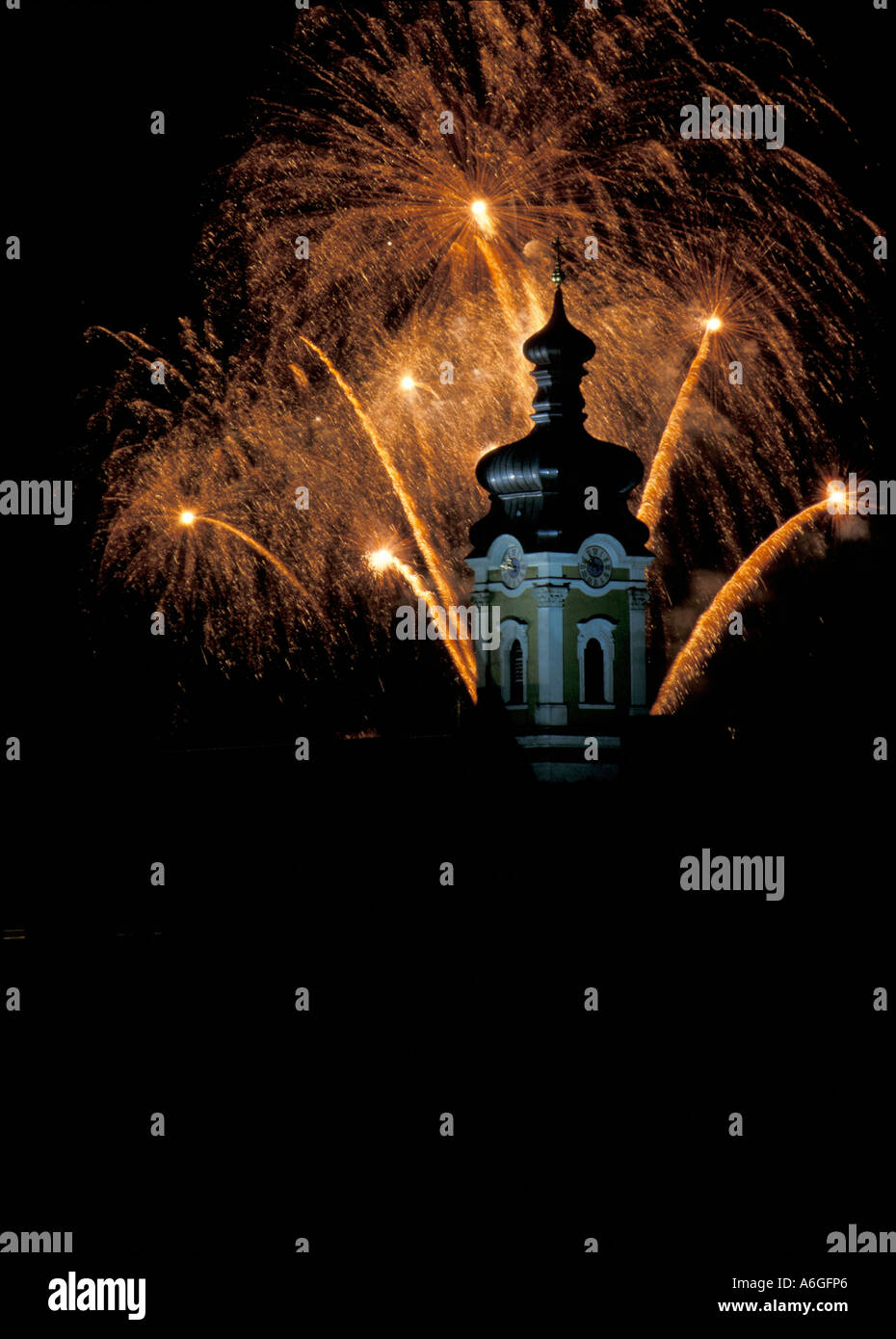 Fireworks behind church tower with onion-dome; Munich (Neuhausen ...