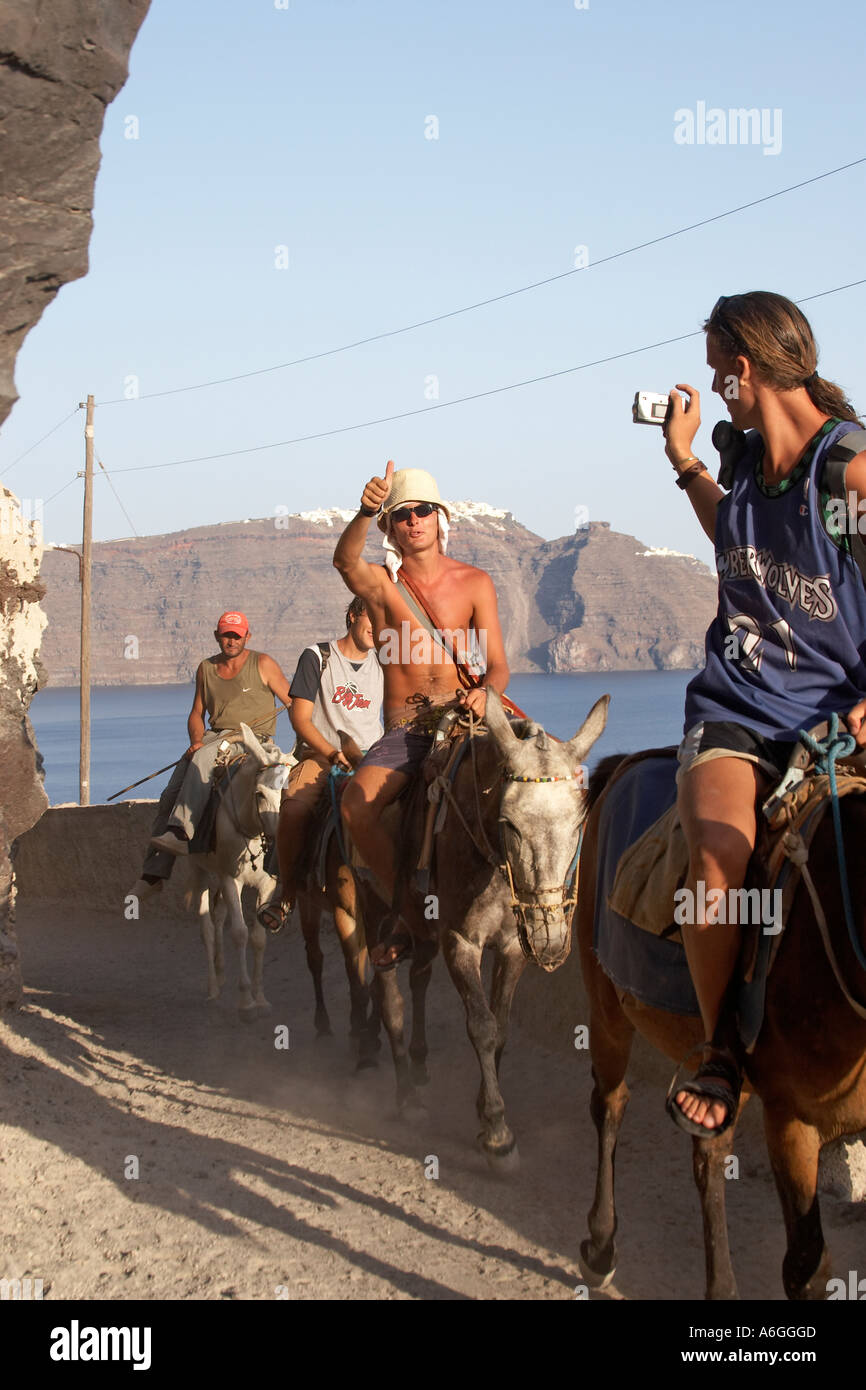 People riding mules or donkeys up the caldera cliff path to Oia or Ia ...