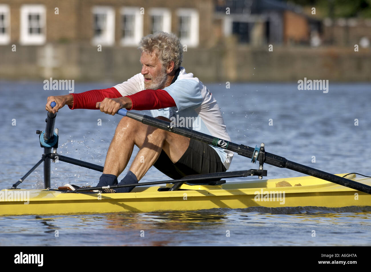Male Man rower rowing a single scull on River Thames at Hammersmith ...