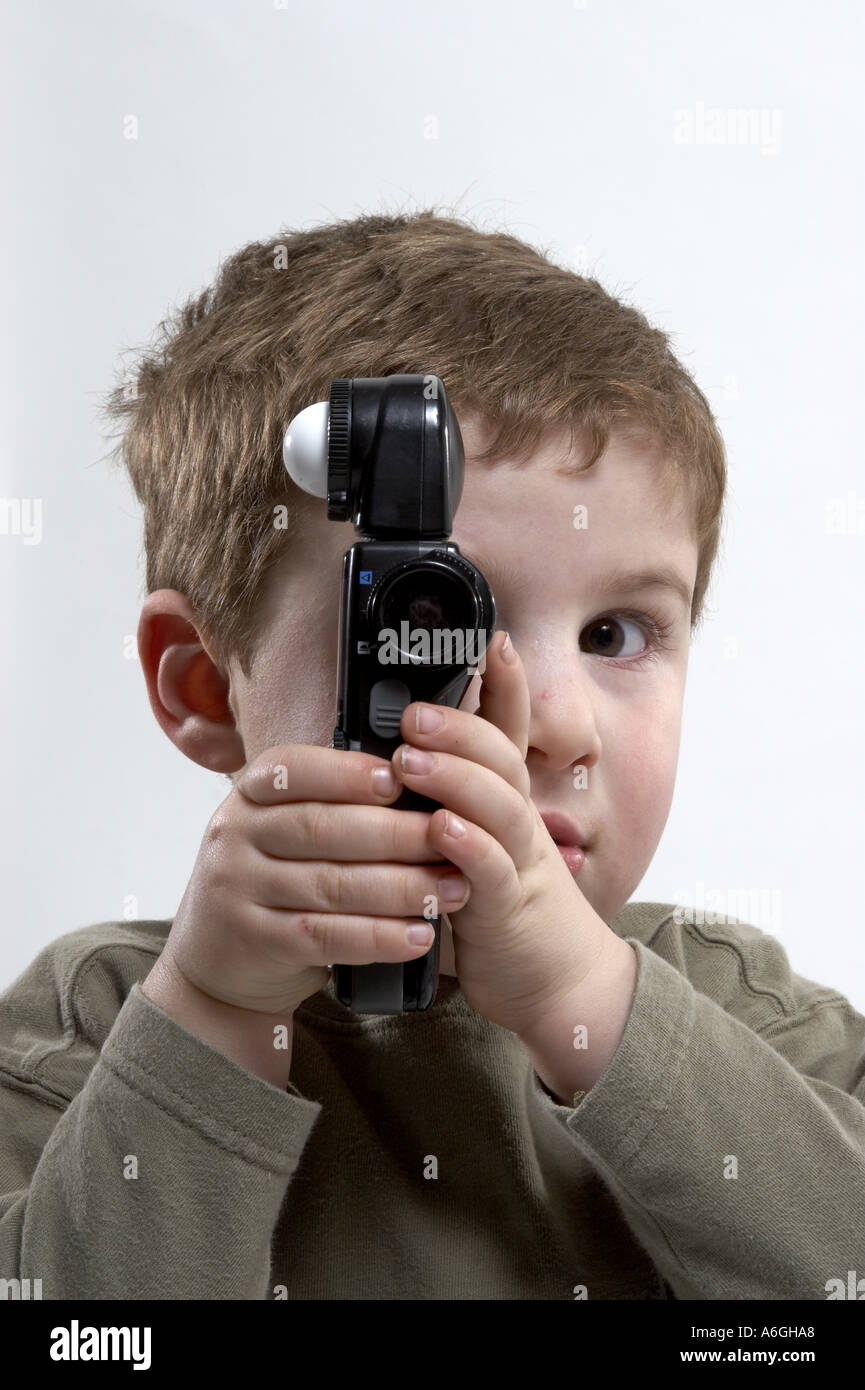 Young boy looking and holding a light spot meter Stock Photo - Alamy