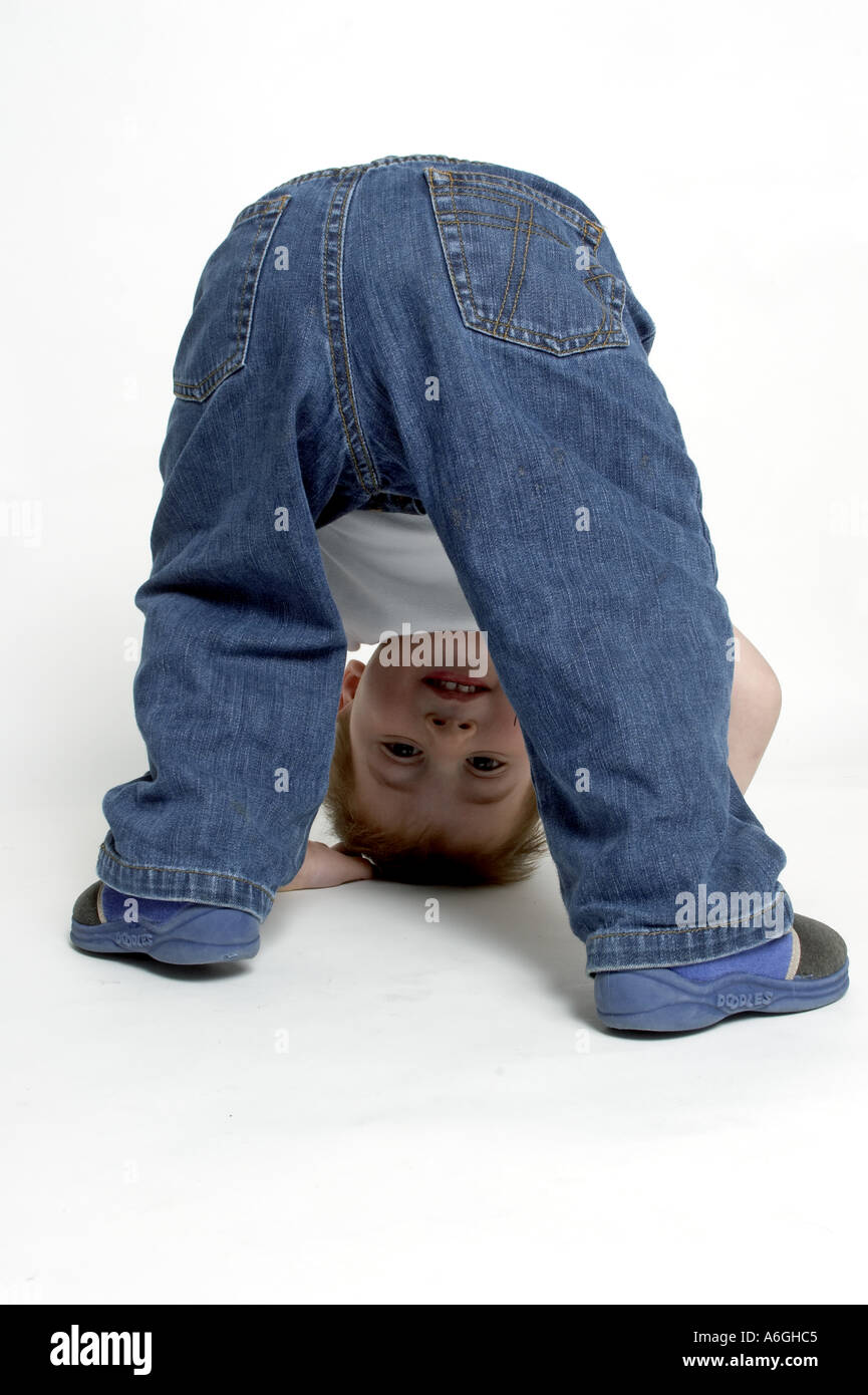 Young boy looking between his legs Stock Photo - Alamy
