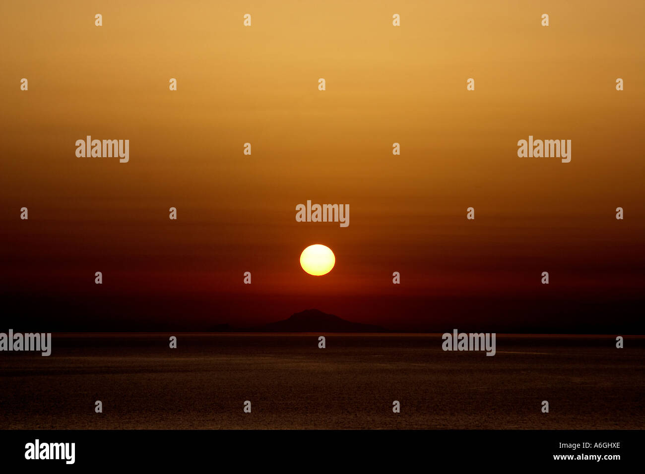 Sunset with sun setting Stock Photo - Alamy