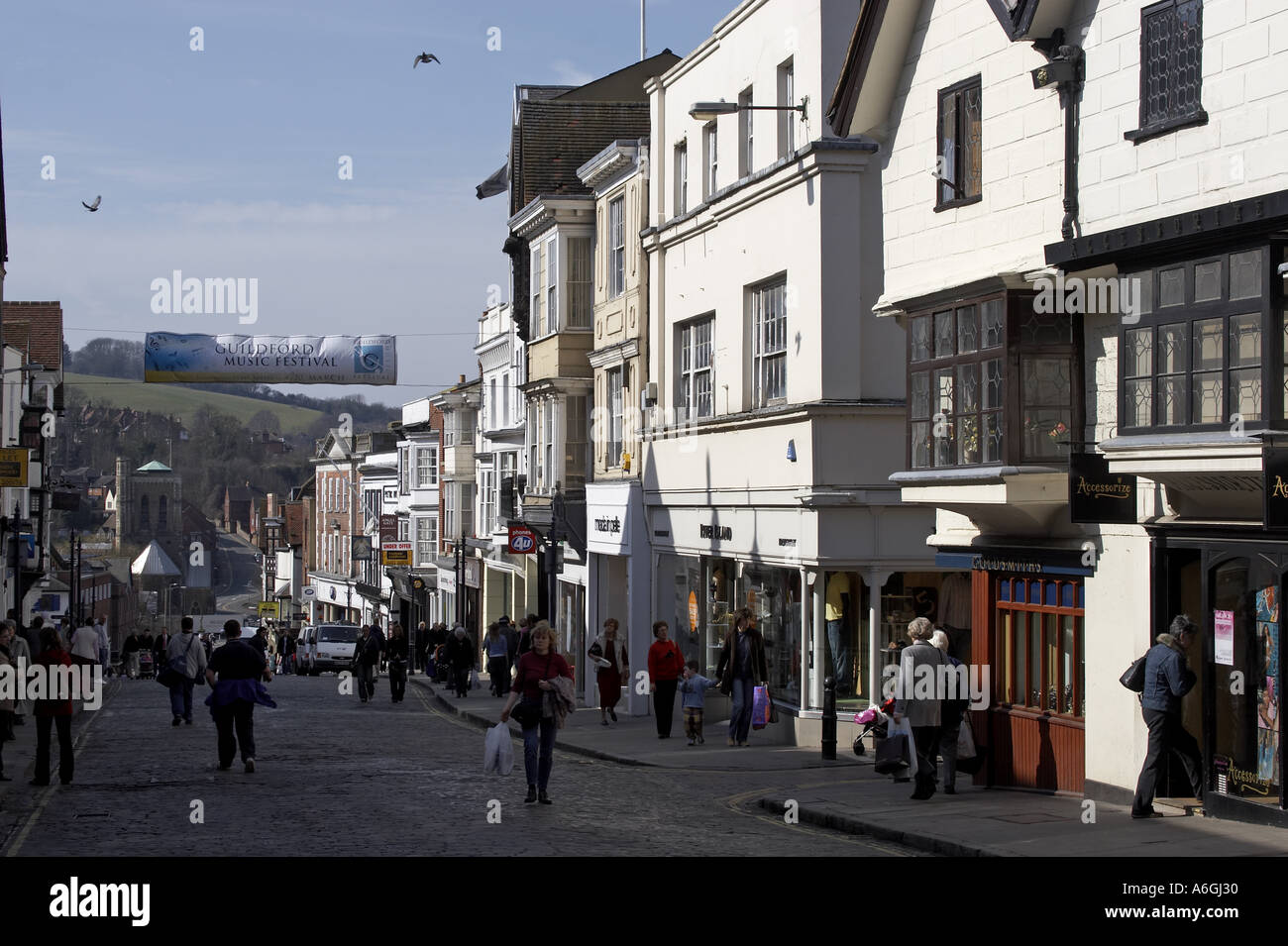 The historic High Street with shoppers Guildford Surrey England Stock ...