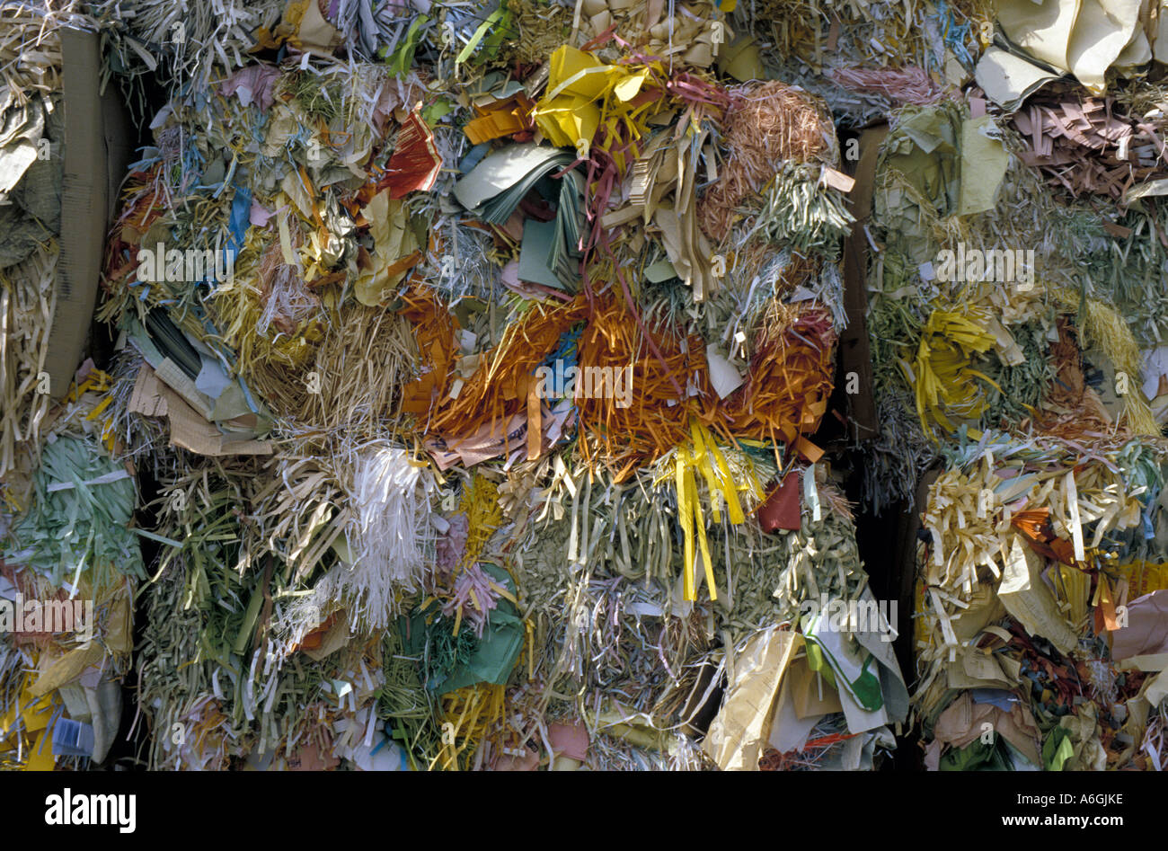 Pile of colored waste paper stripes in bales Stock Photo - Alamy