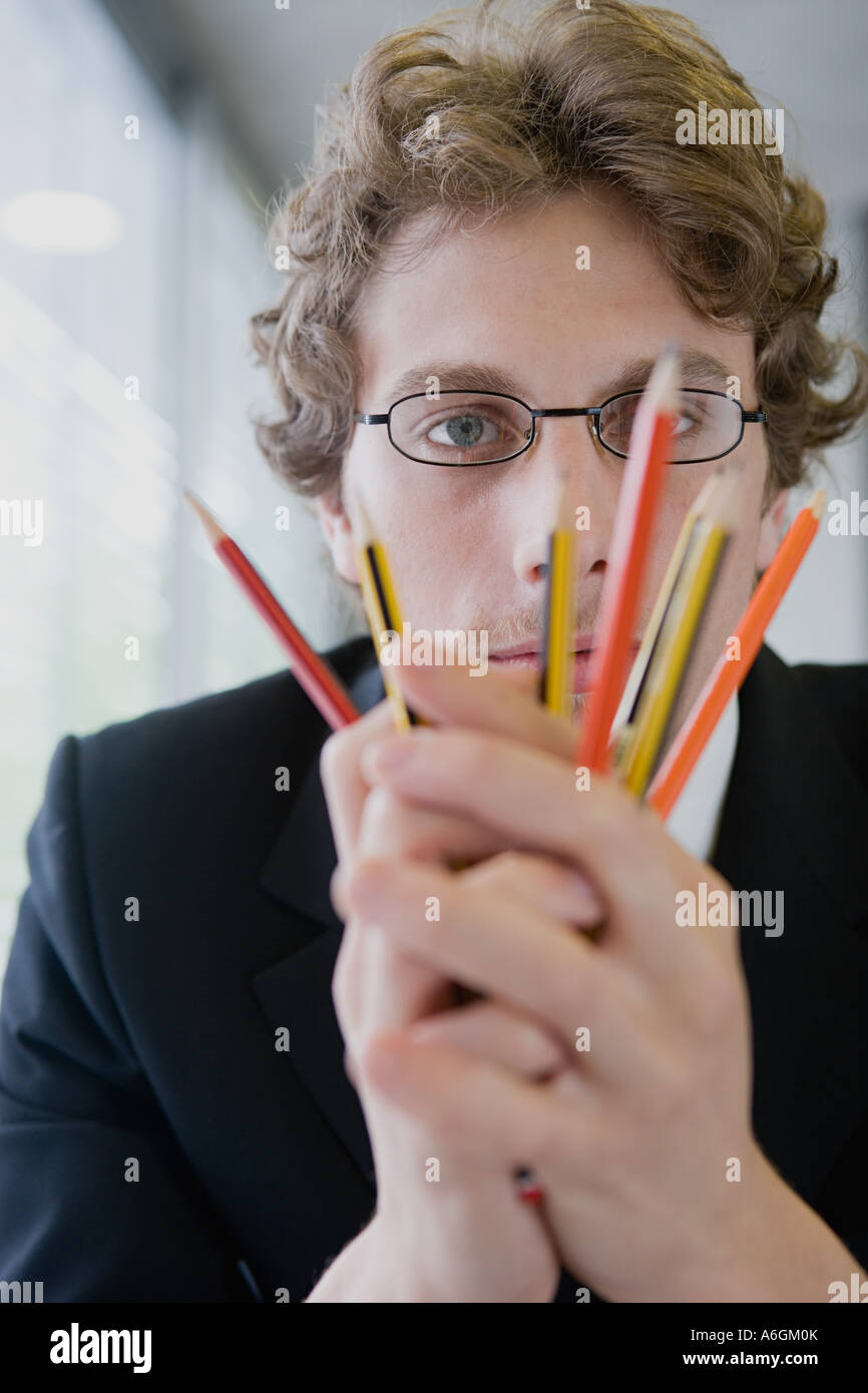 Man holding pencils Stock Photo - Alamy