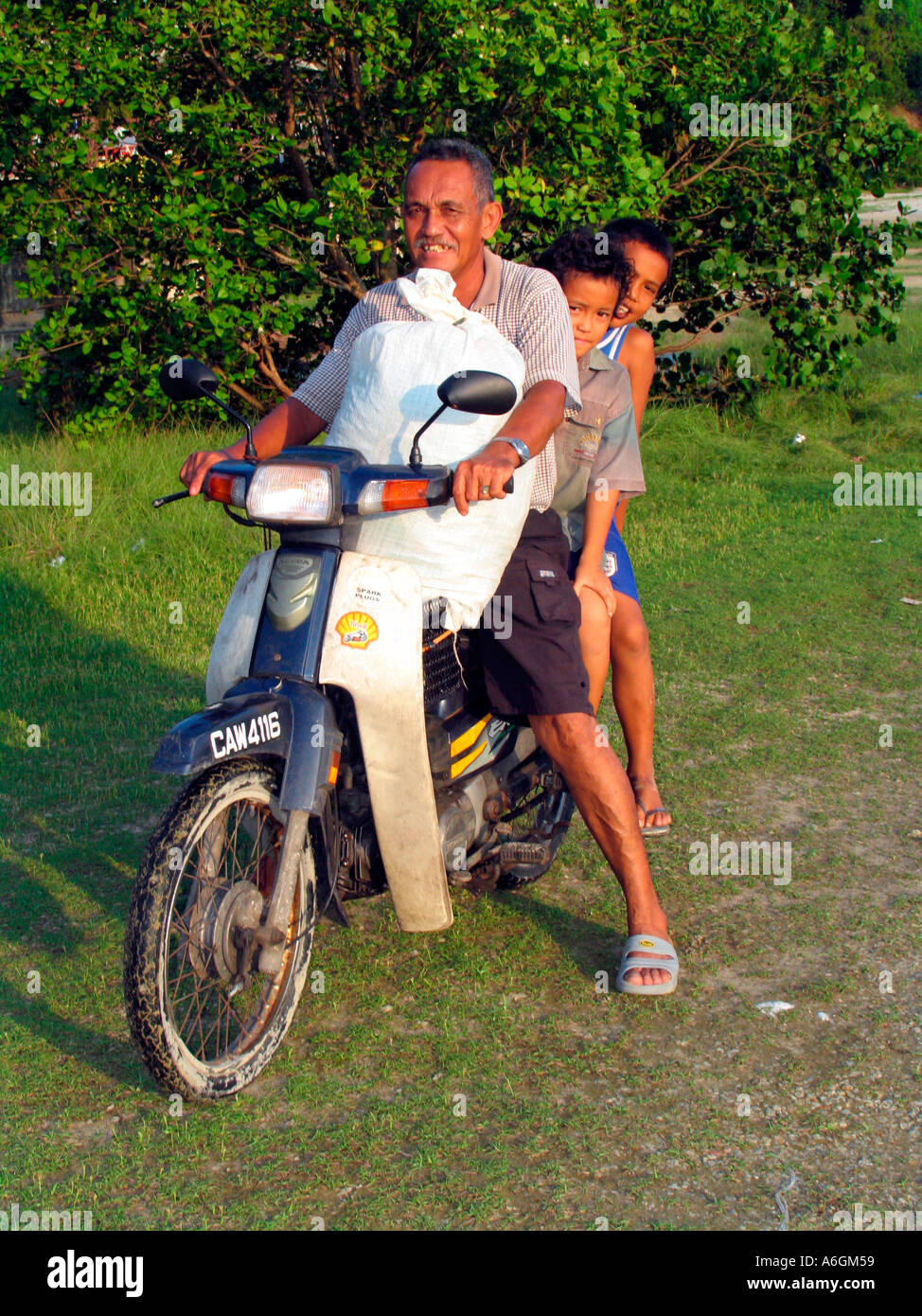 Man on loaded moped hi-res stock photography and images - Alamy