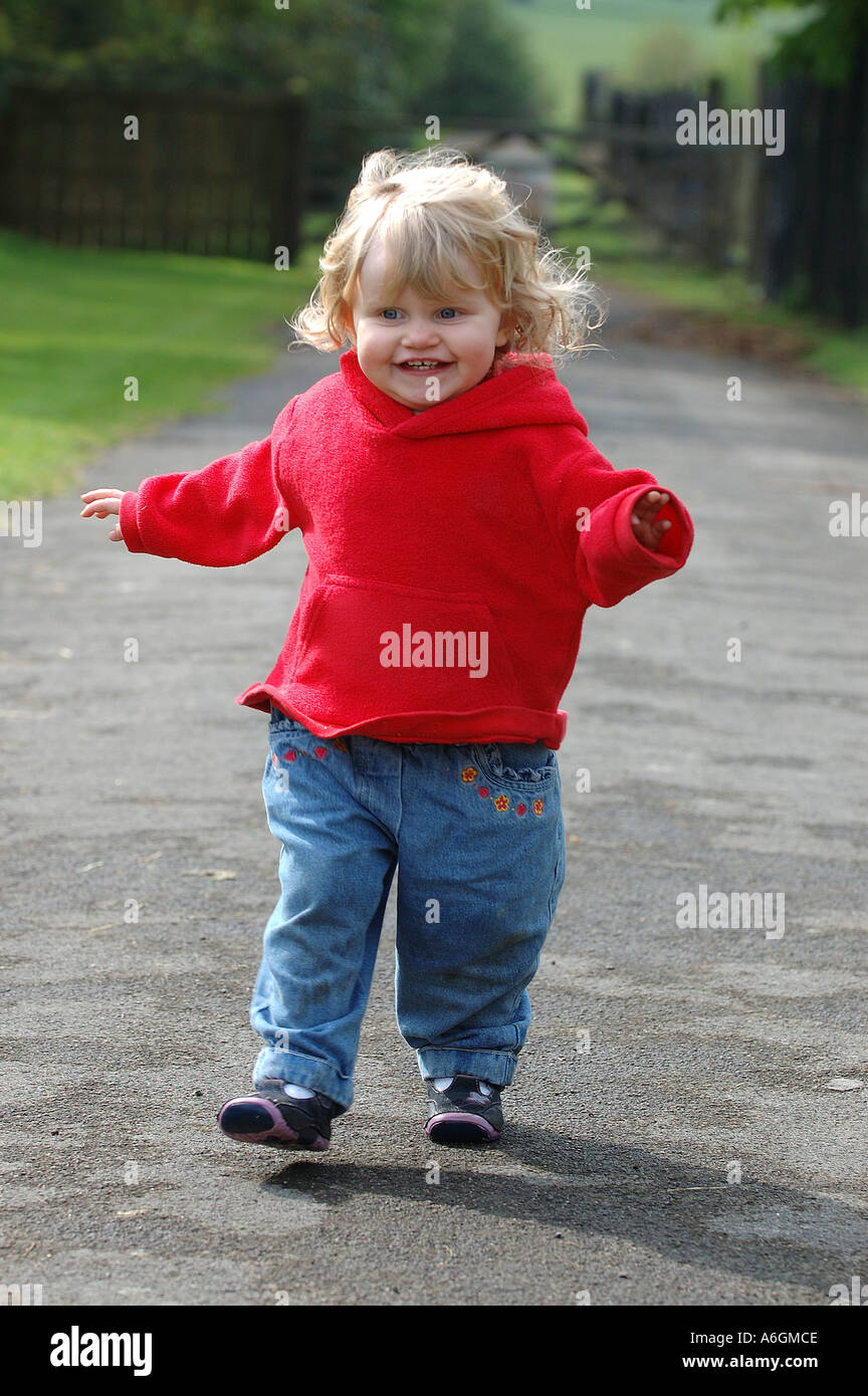 Female toddler learning to walk forst steps Stock Photo - Alamy