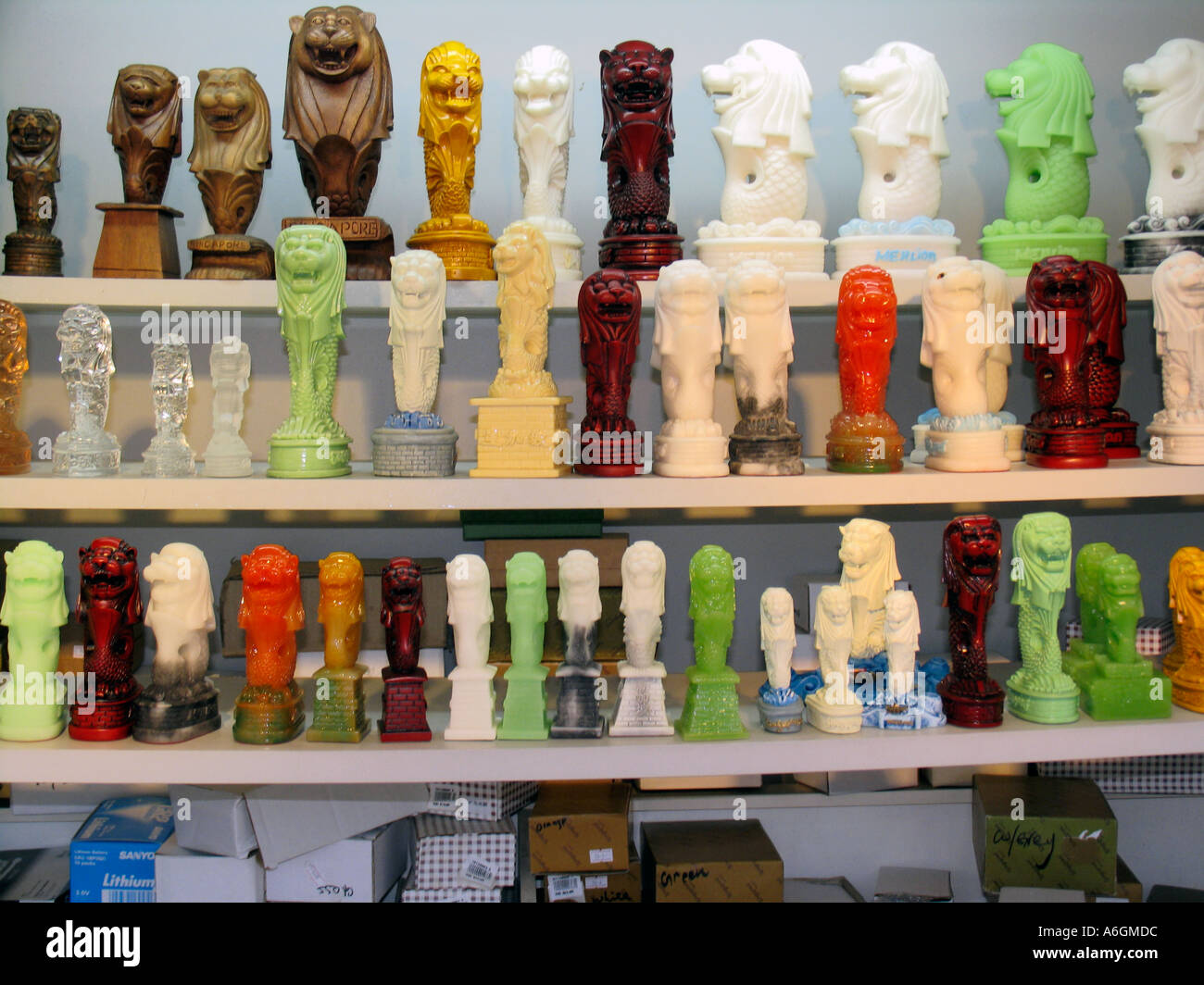 Stall with shelves of miniature carved merlion souvenirs beside the ...