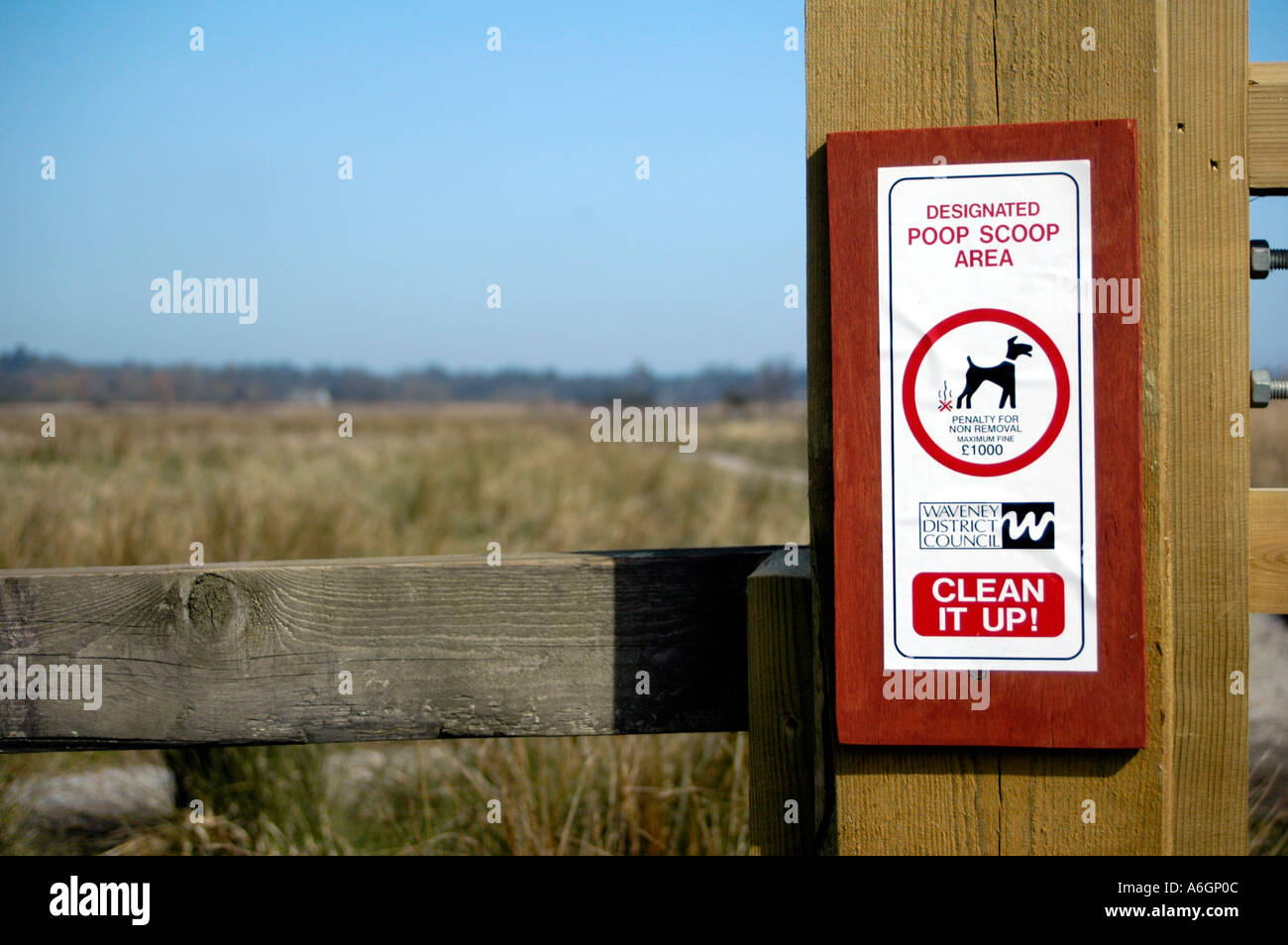 Poop Scoop sign on a gate post Stock Photo - Alamy