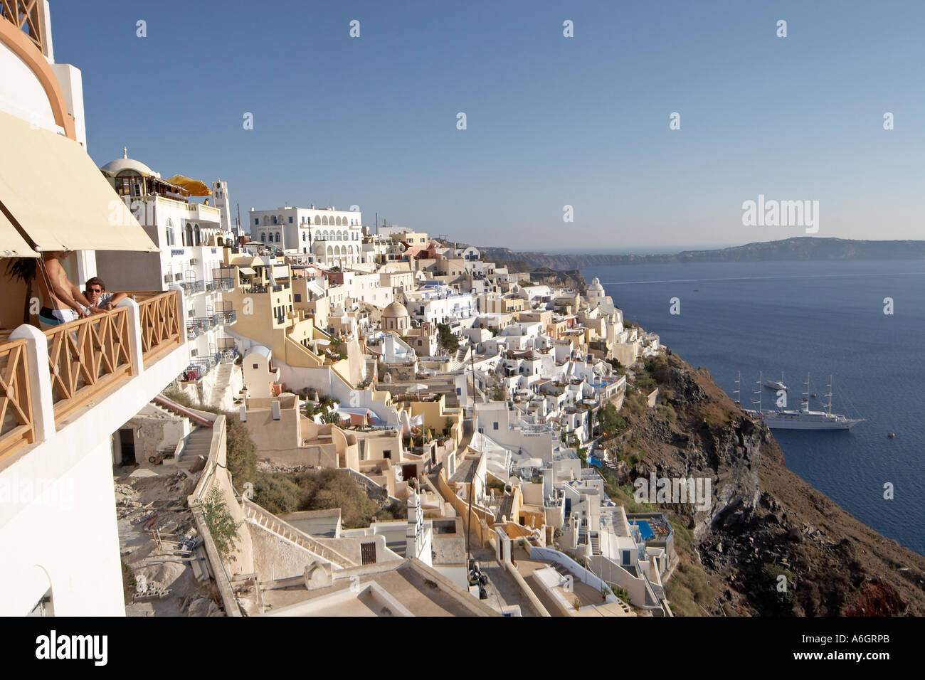 Afternoon view north of houses hotels and buildings on caldera cliff ...