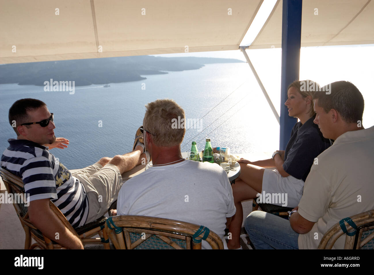 People relaxing and drinking in a bar high above the sea in town of ...
