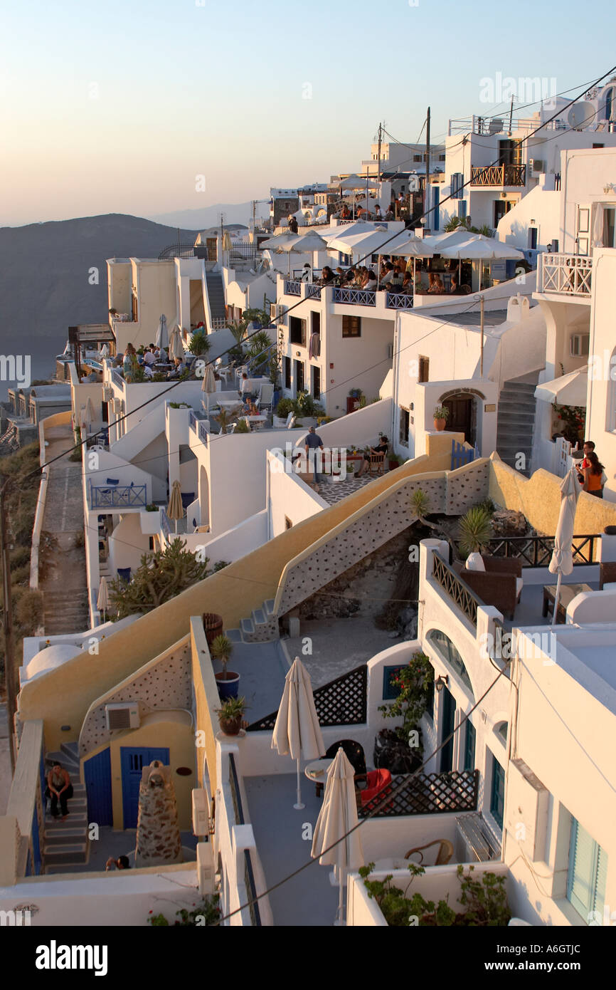 Houses on the edge of the caldera cliff at dusk in town of Imerovigli ...