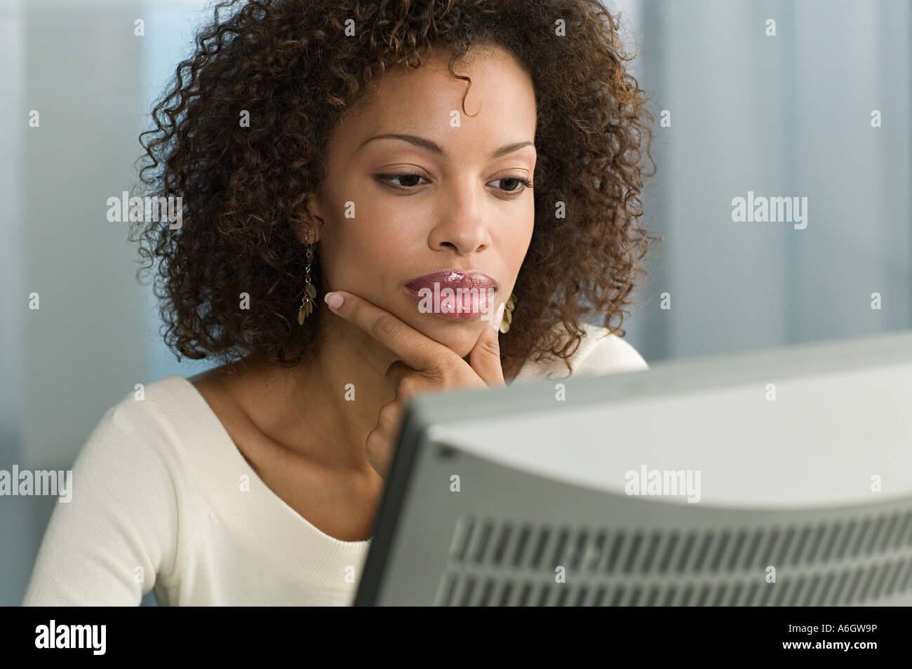 Woman looking at computer Stock Photo - Alamy