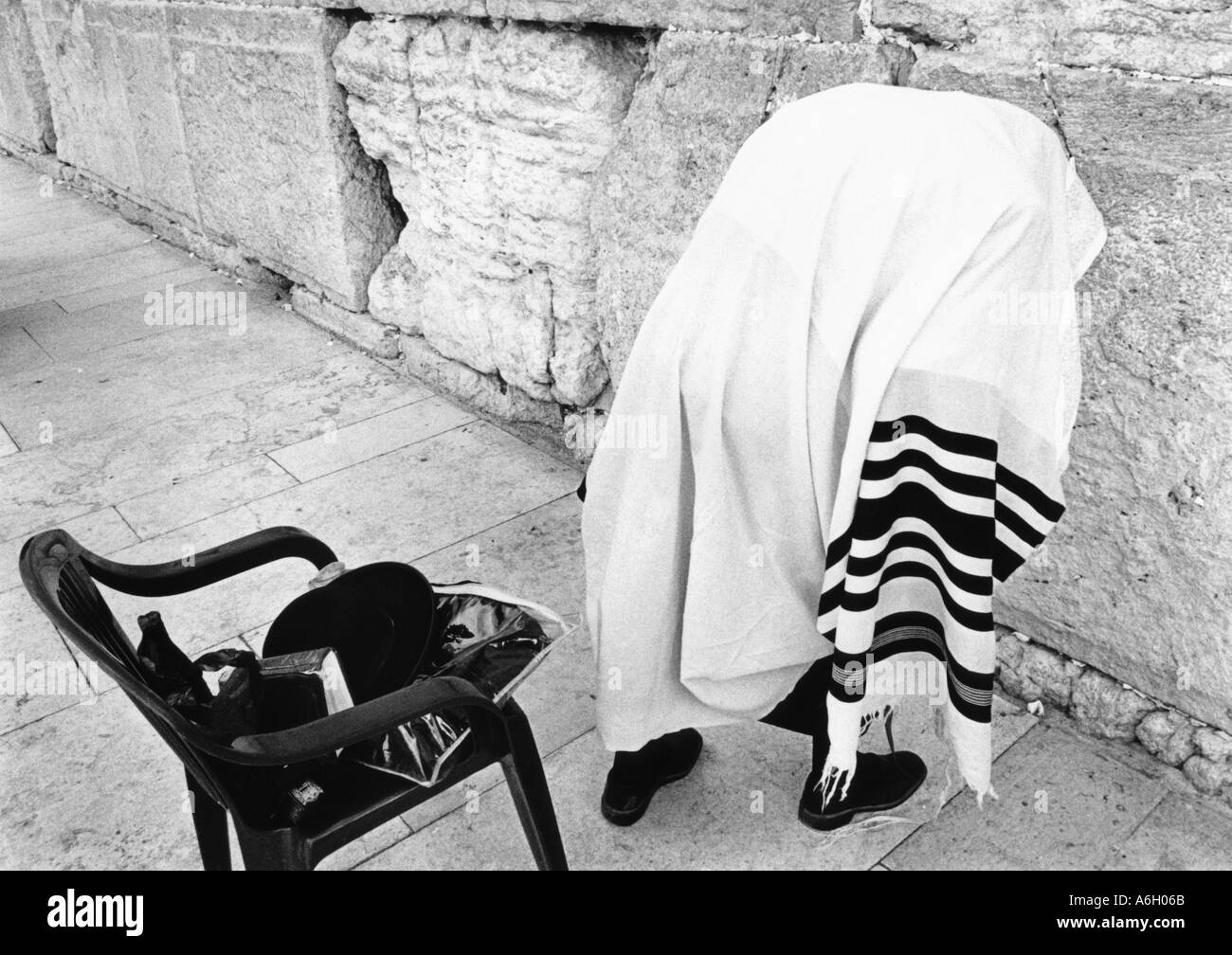 orthodox jew under his praying shawl praying at the Western Wall black ...