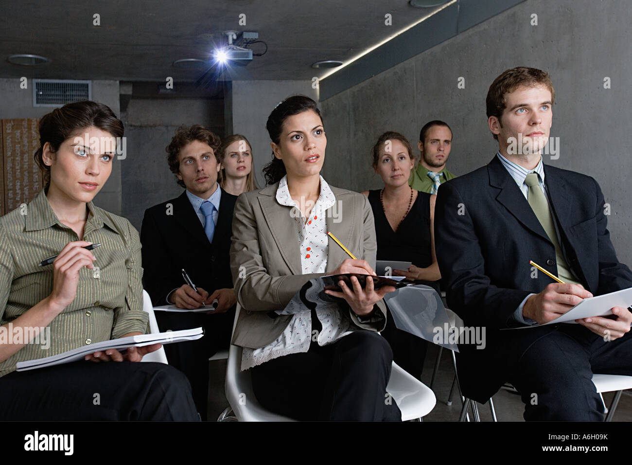 People making notes in a presentation Stock Photo - Alamy