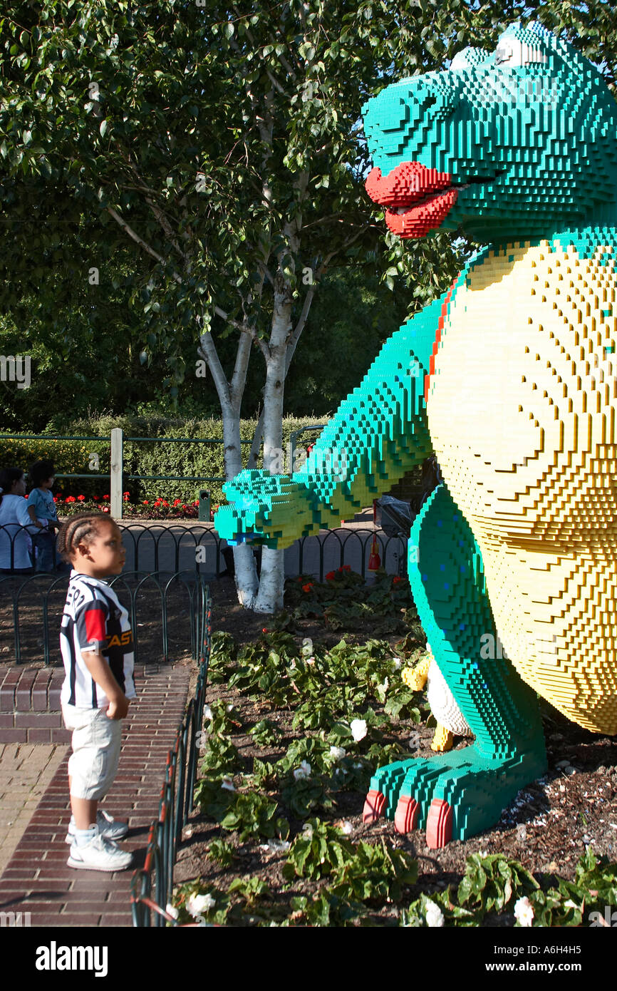 Child looking at model dinosaur figure in Legoland adventure theme park ...