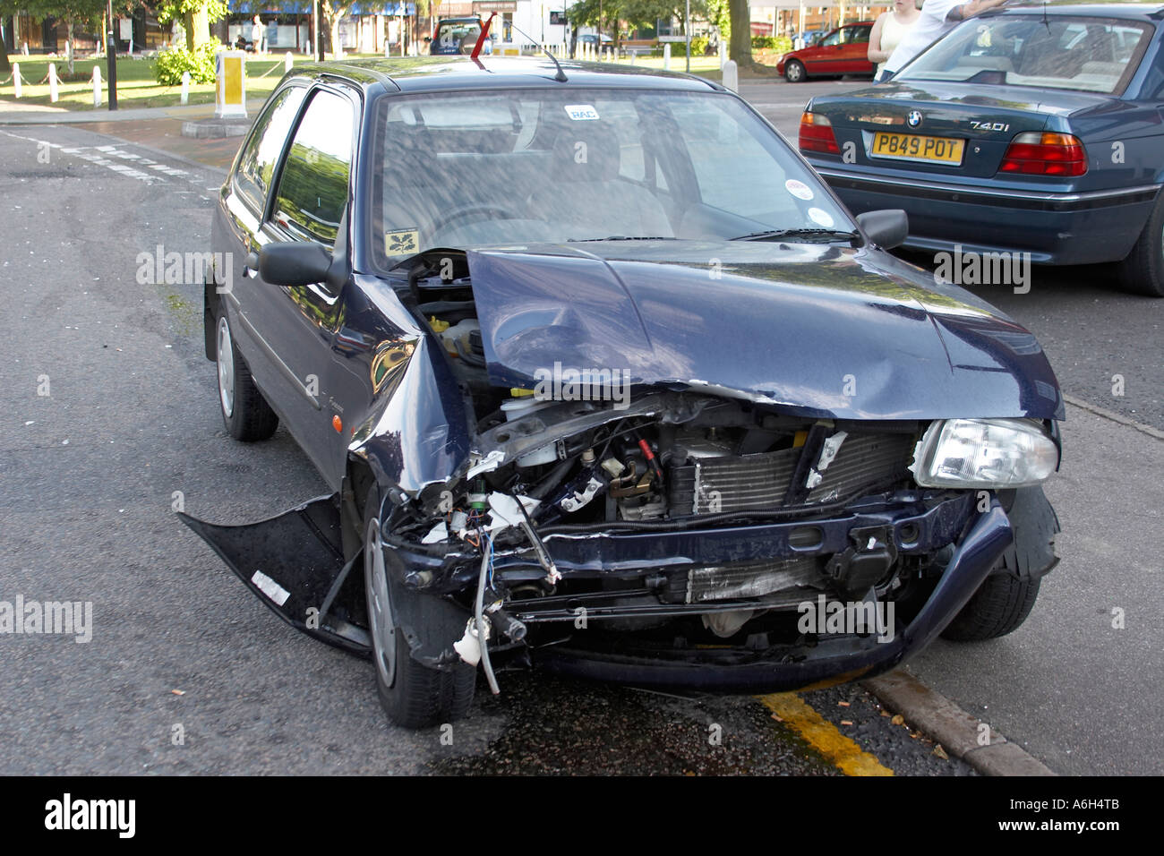 Smashed up damaged car from road traffic accident parked on the side of ...
