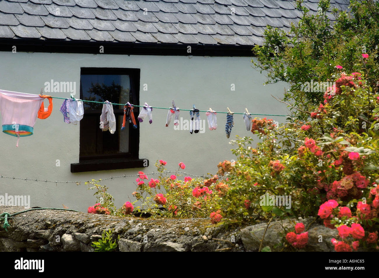 Cottage window with clothes line on Innishboffin Stock Photo - Alamy