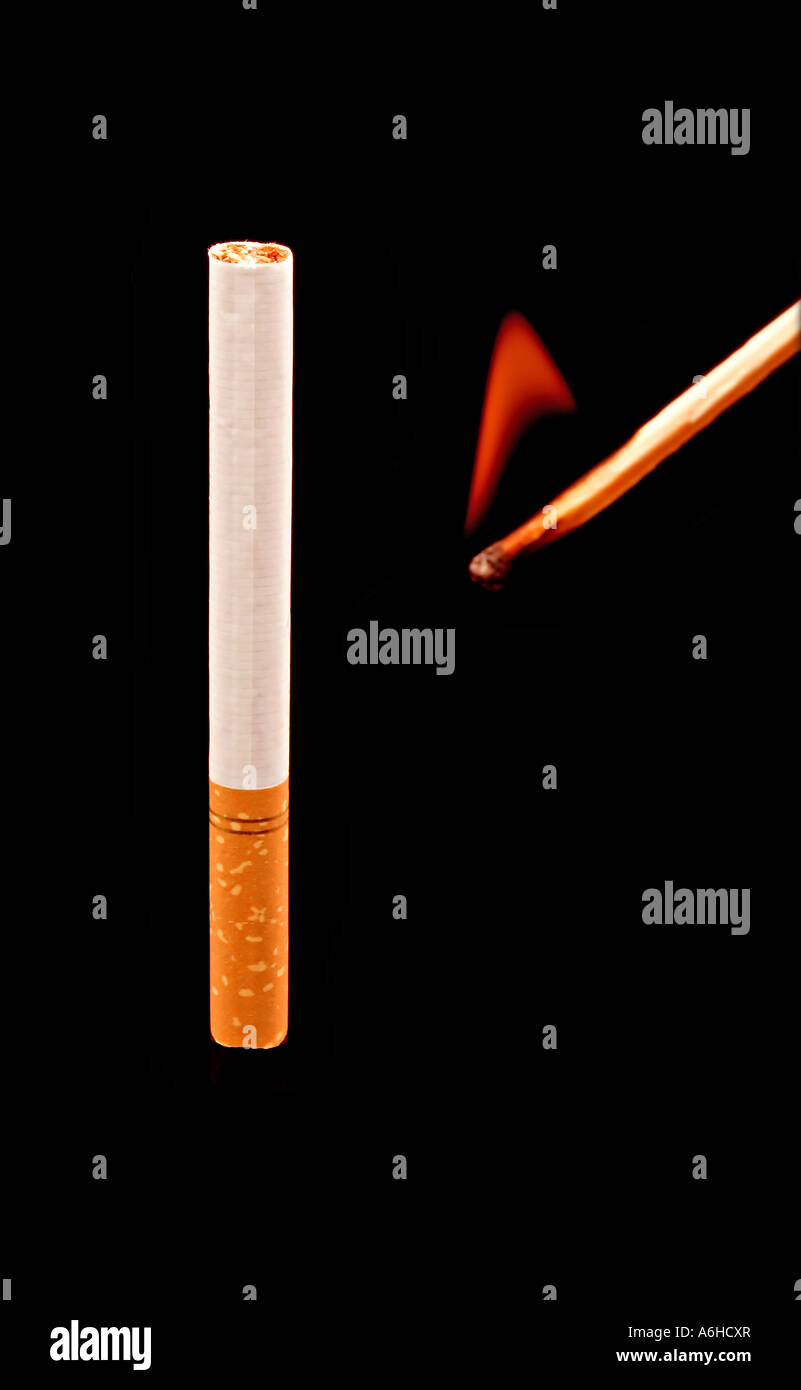 Cigarette with lit match on black background Stock Photo - Alamy