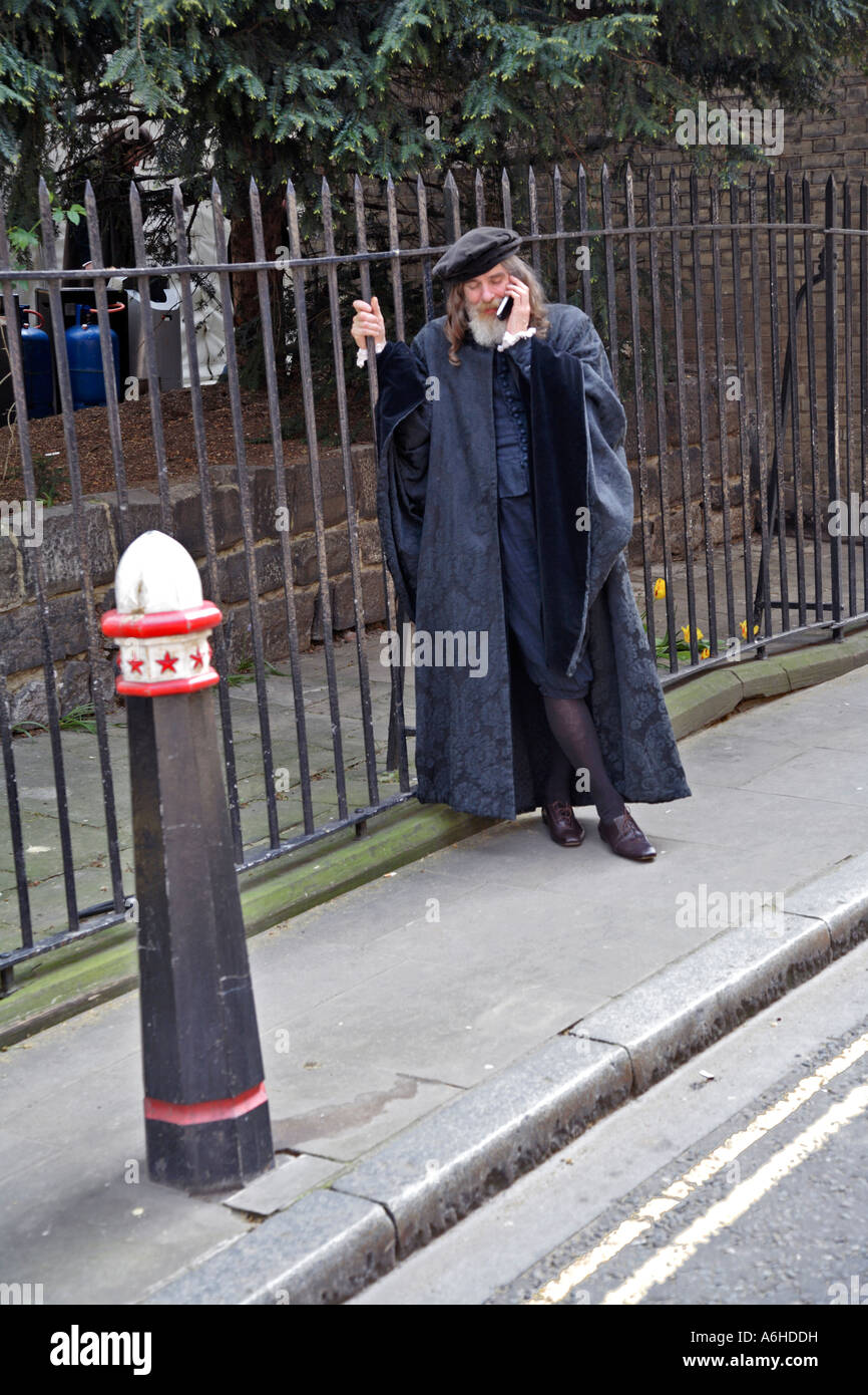 An actor dressed as a medieval character talks into a mobile phone ...