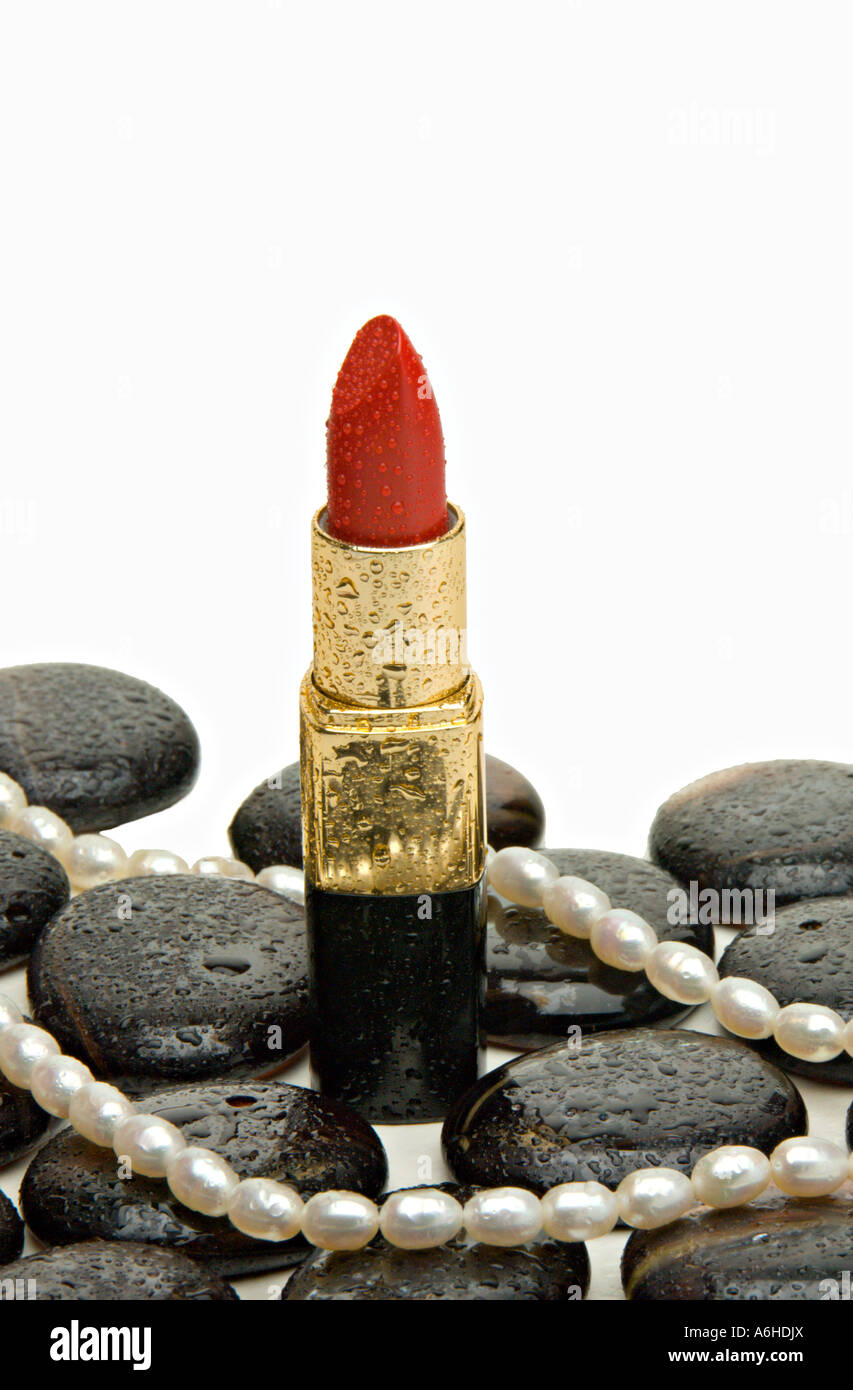 Red lipstick with black pebbles and pearls Stock Photo - Alamy