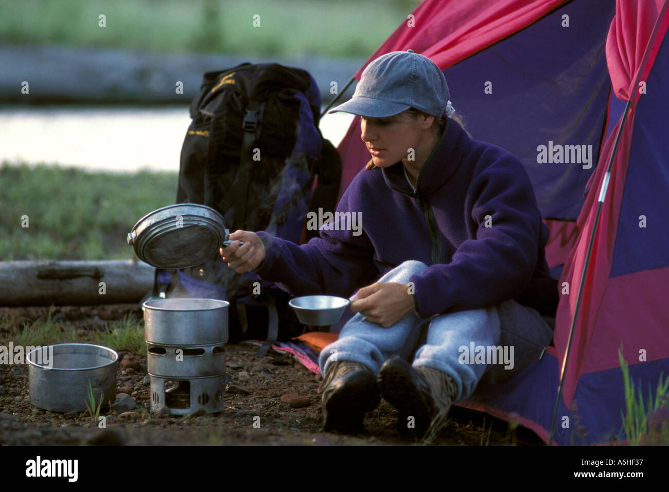 Woman Cooking Over Campfire Stock Photo - Alamy