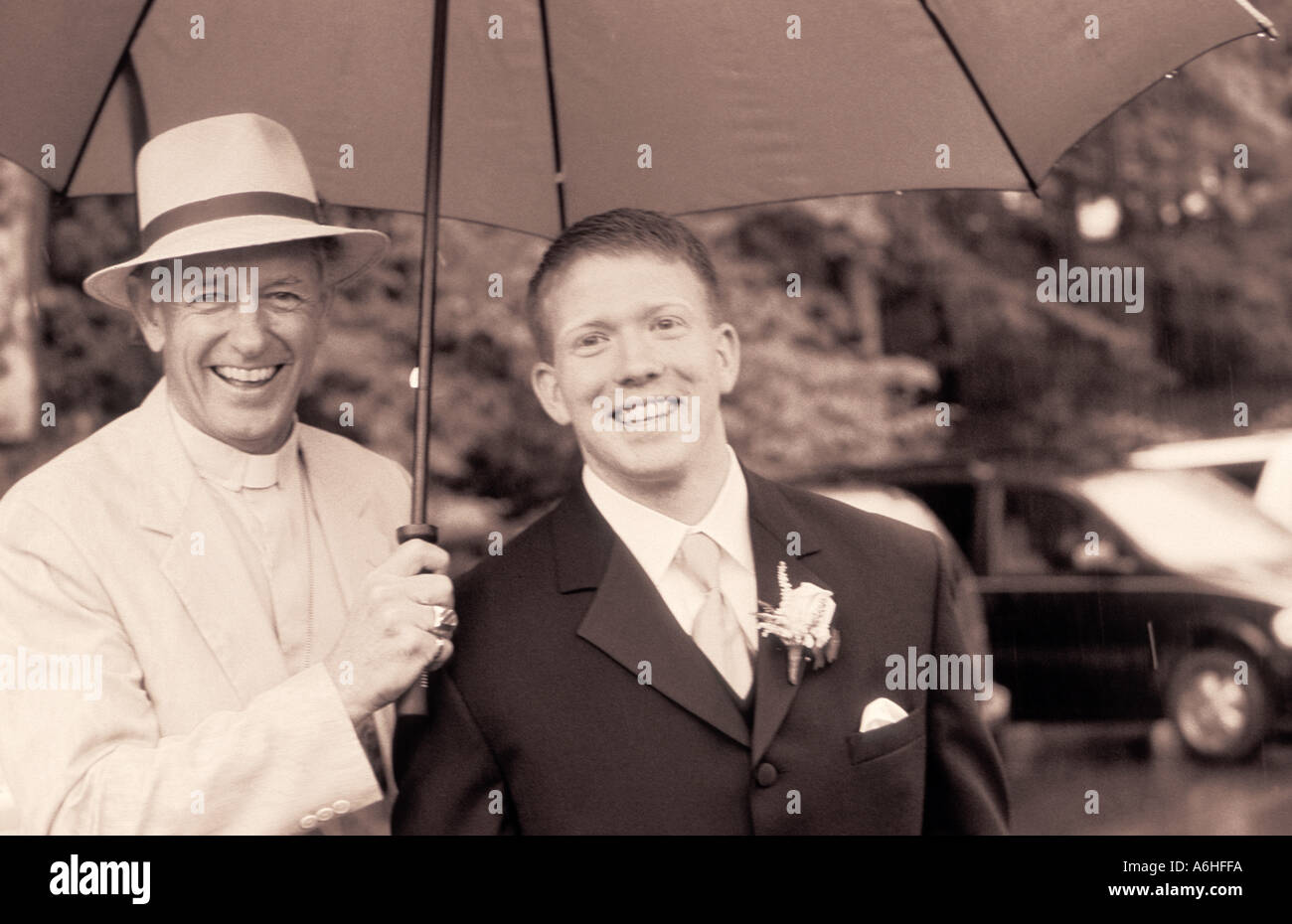 Two Happy Men and an Umbrella Stock Photo - Alamy