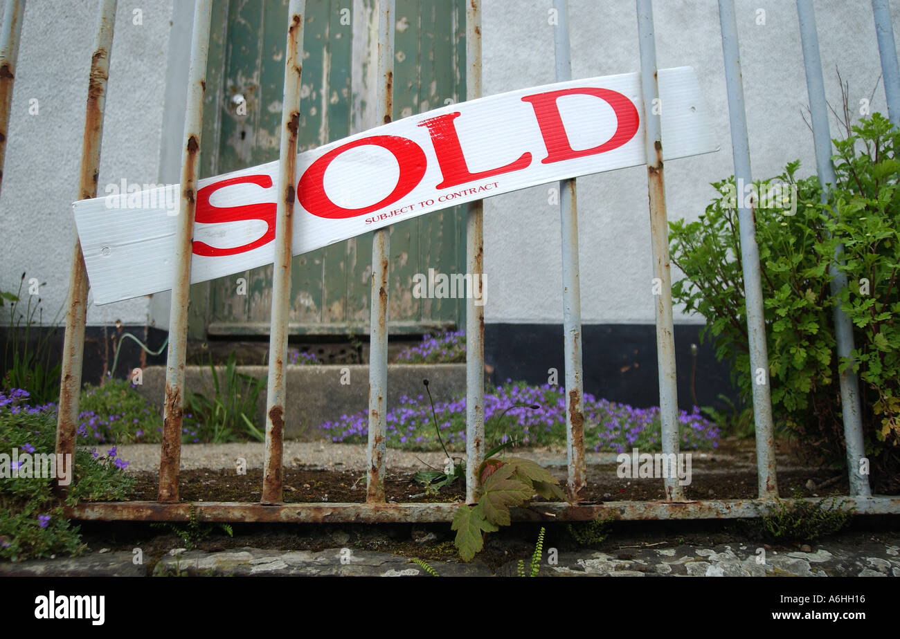 a sold sign hanging off the railings of a building Stock Photo - Alamy