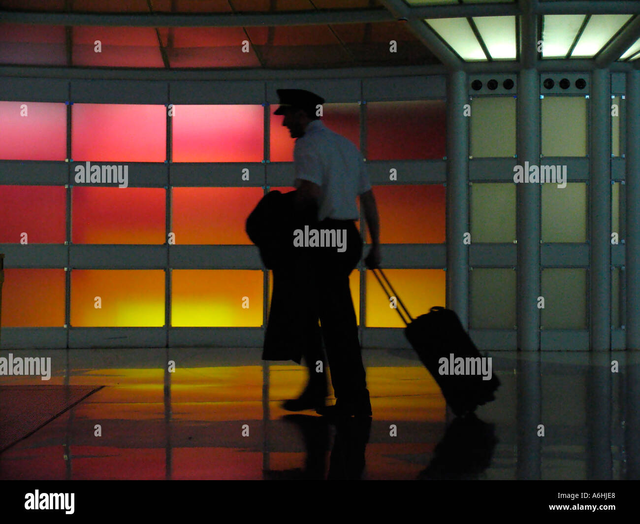 Airline pilot with wheeled trolley United Airlines terminal tunnel ...