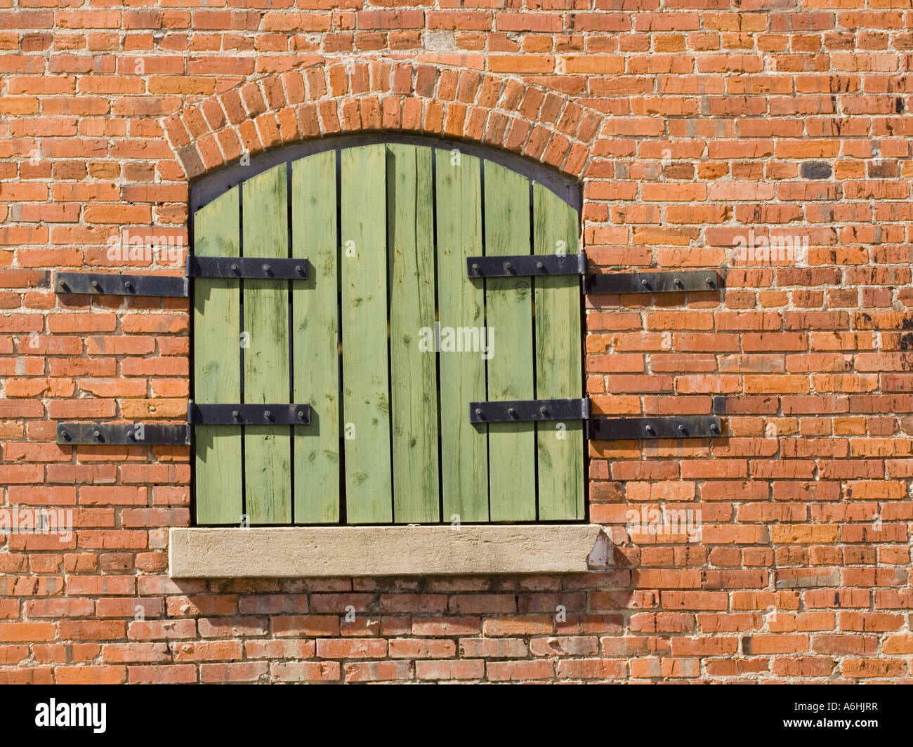 Shuttered window in brick wall Stock Photo - Alamy