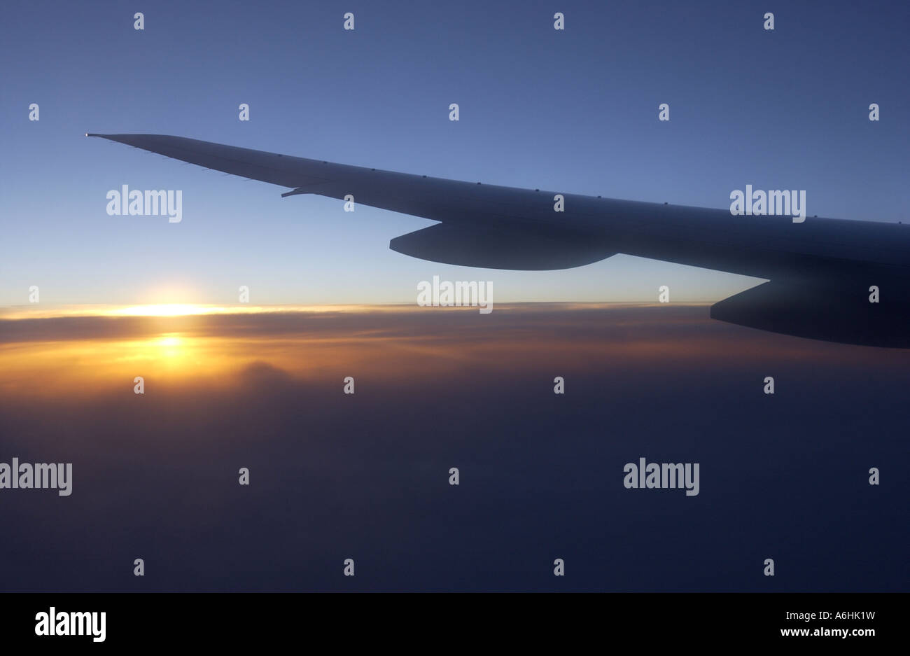 View of wing and sunset out the window of a passenger airliner Stock ...
