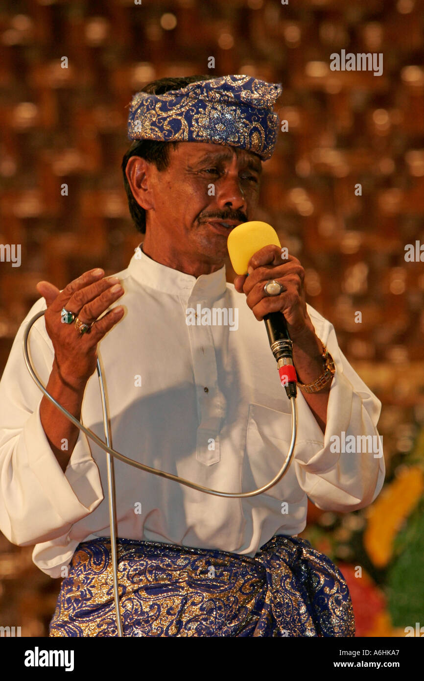 Male singer in traditonal costume performs with Malaysian percussion ...