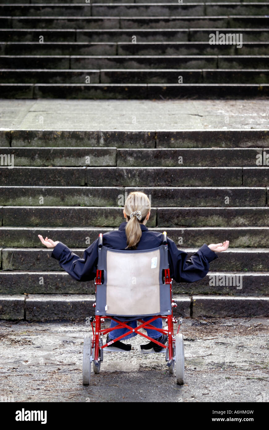 Disabled woman in wheelchair unable to climb large stairway steps Stock ...