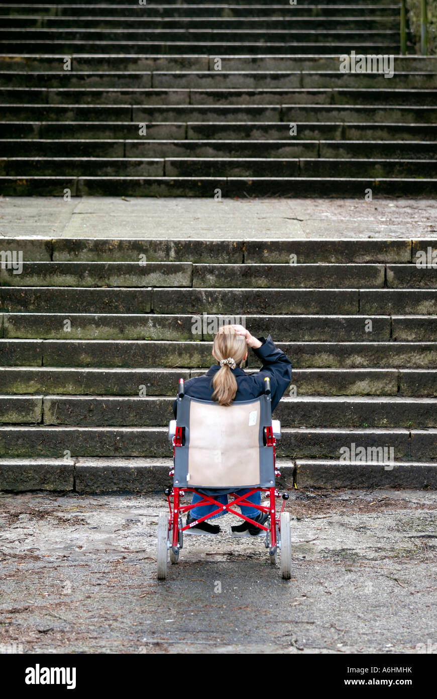 Disabled woman in wheelchair unable to climb large stairway steps Stock ...