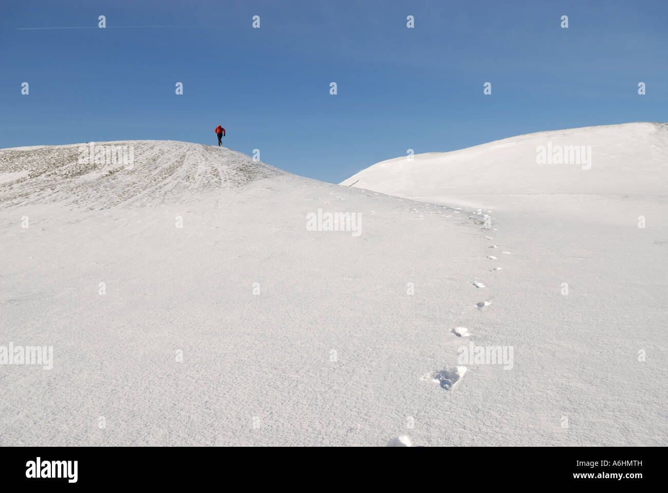 distant man trail running in winter scene Stock Photo - Alamy
