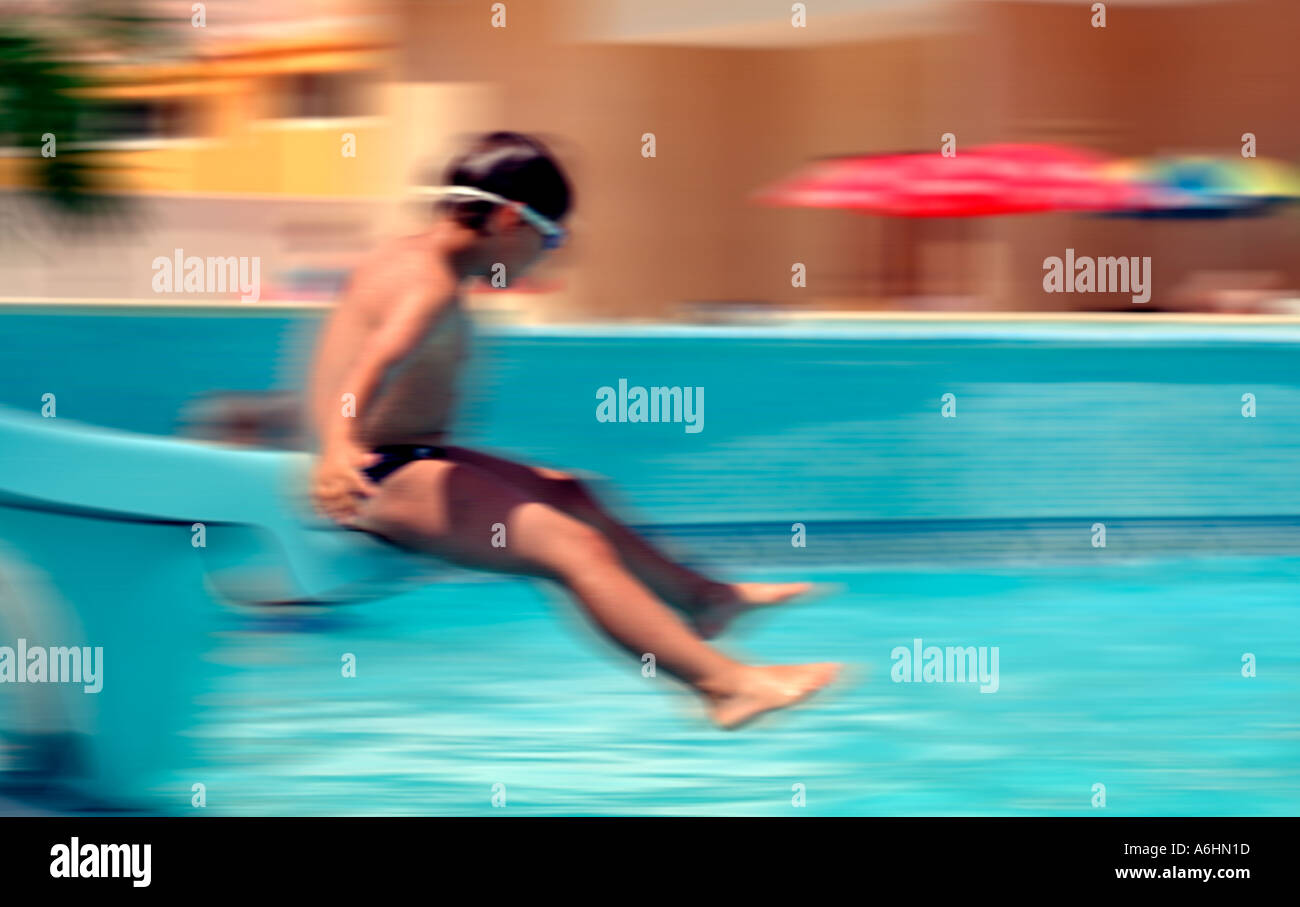 Boy Sliding Into Pool In Sunny Beach Resort In Bulgaria Stock Photo - Alamy