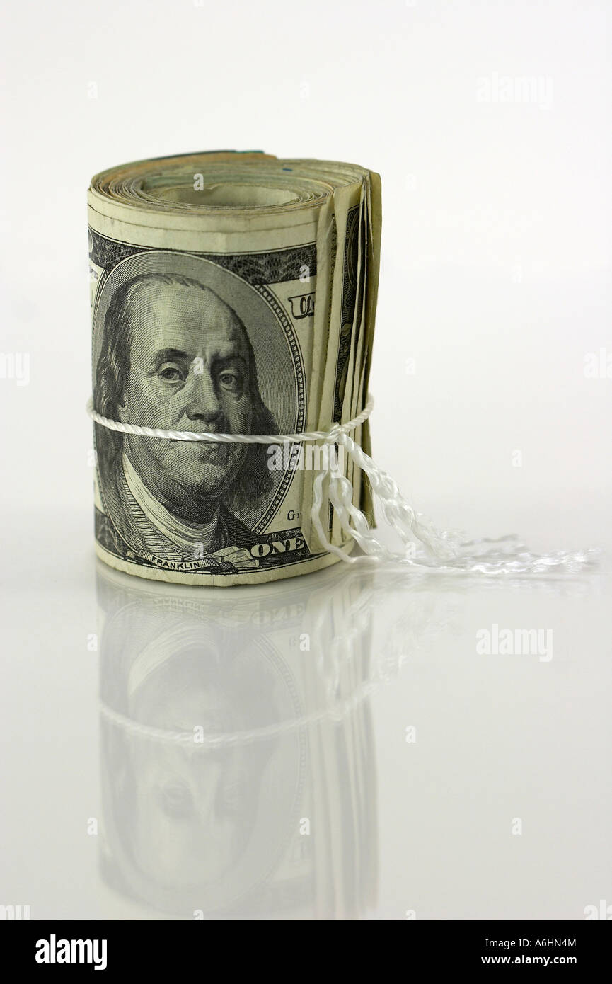 United States Currency in a roll tied with a white string Stock Photo ...