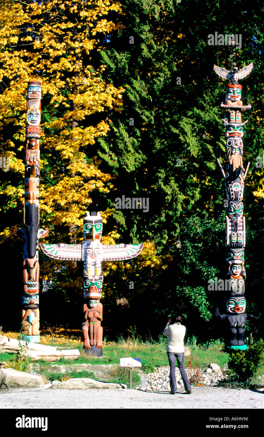 Woman photographing Totem poles.Stanley Park.Vancouver.British Columbia ...